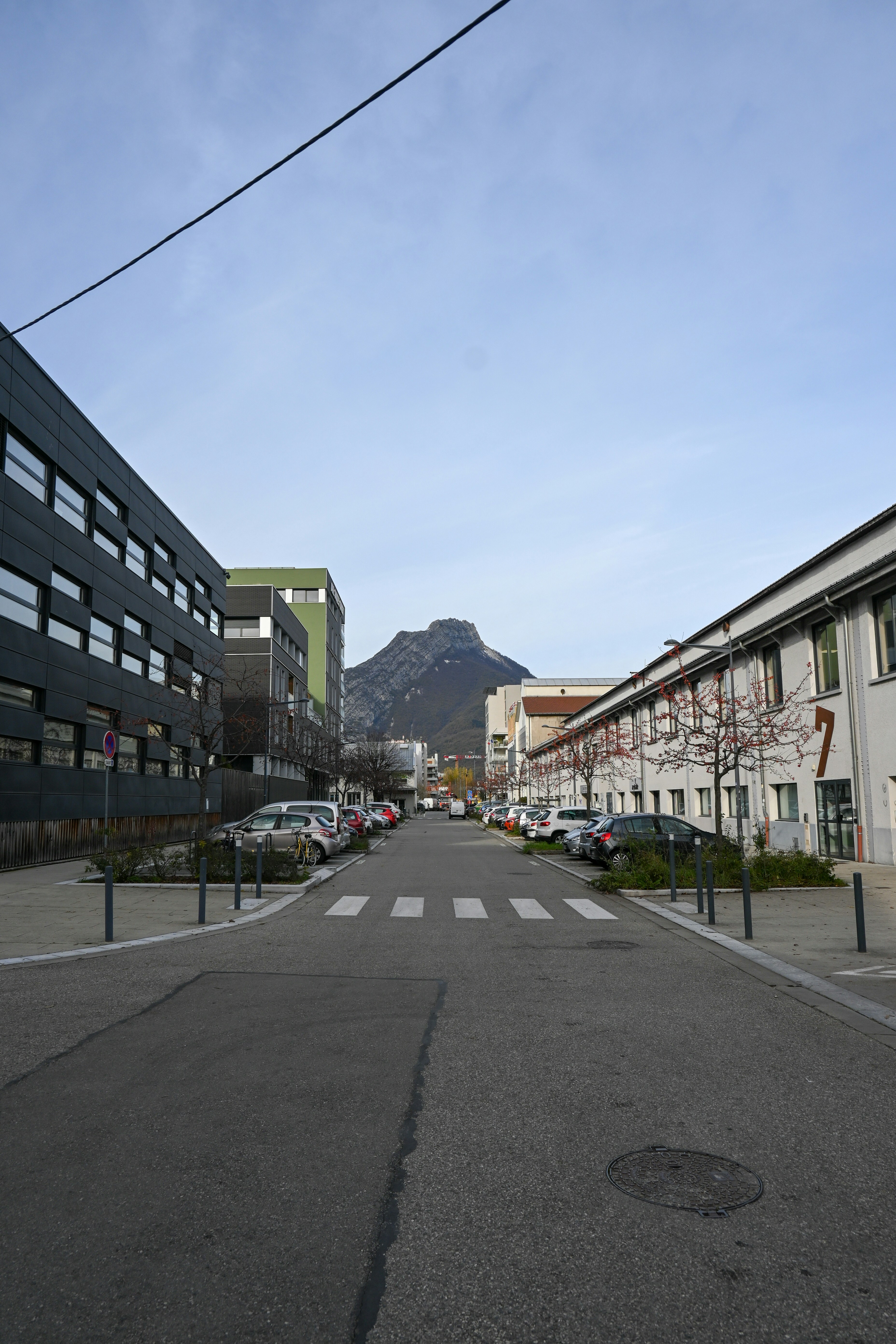 Horizon Convergence: A Quiet Street Framing a Distant Mountain Peak