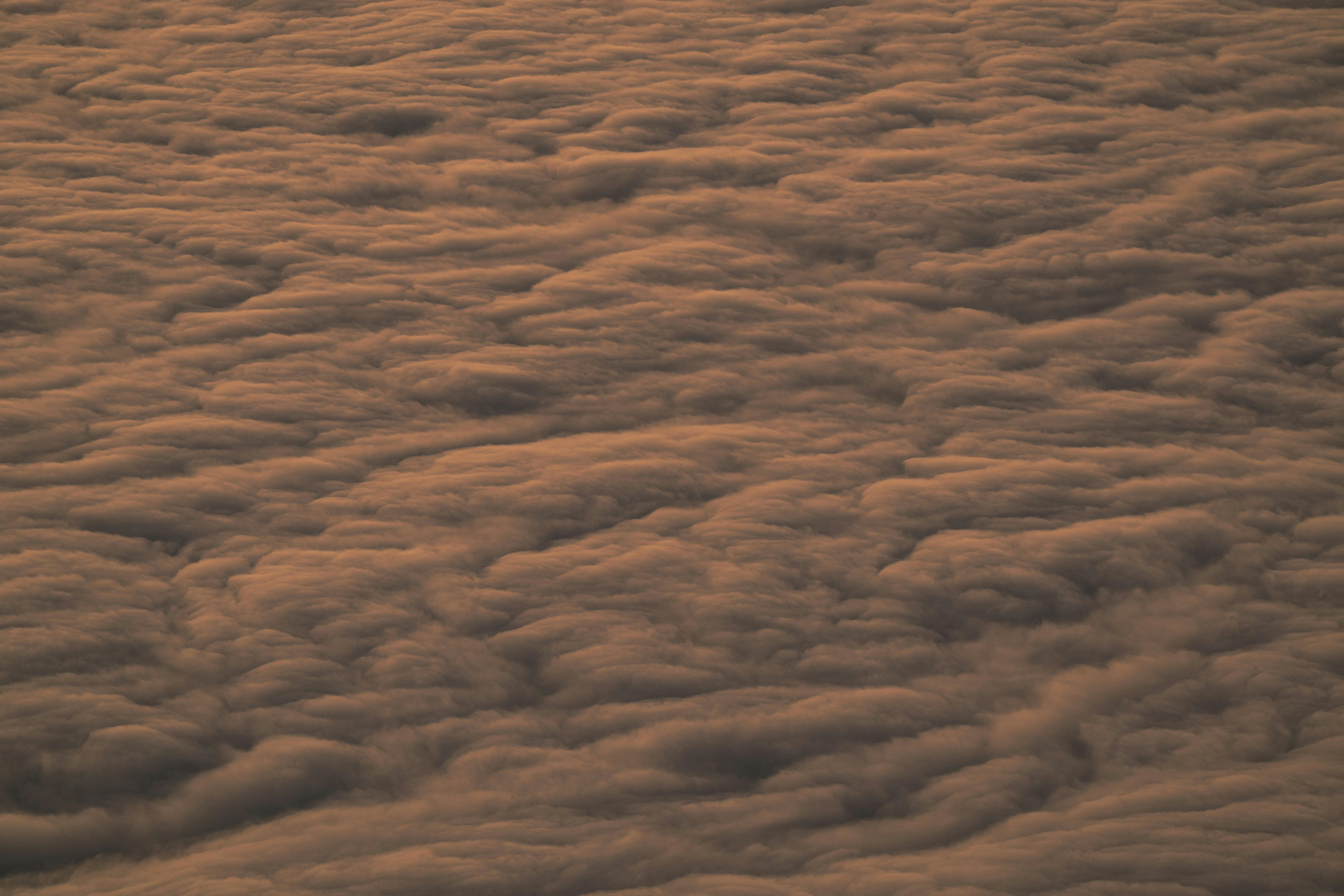Ember-Soft Cloudscape: A Quiet Sunset Blanket Aloft