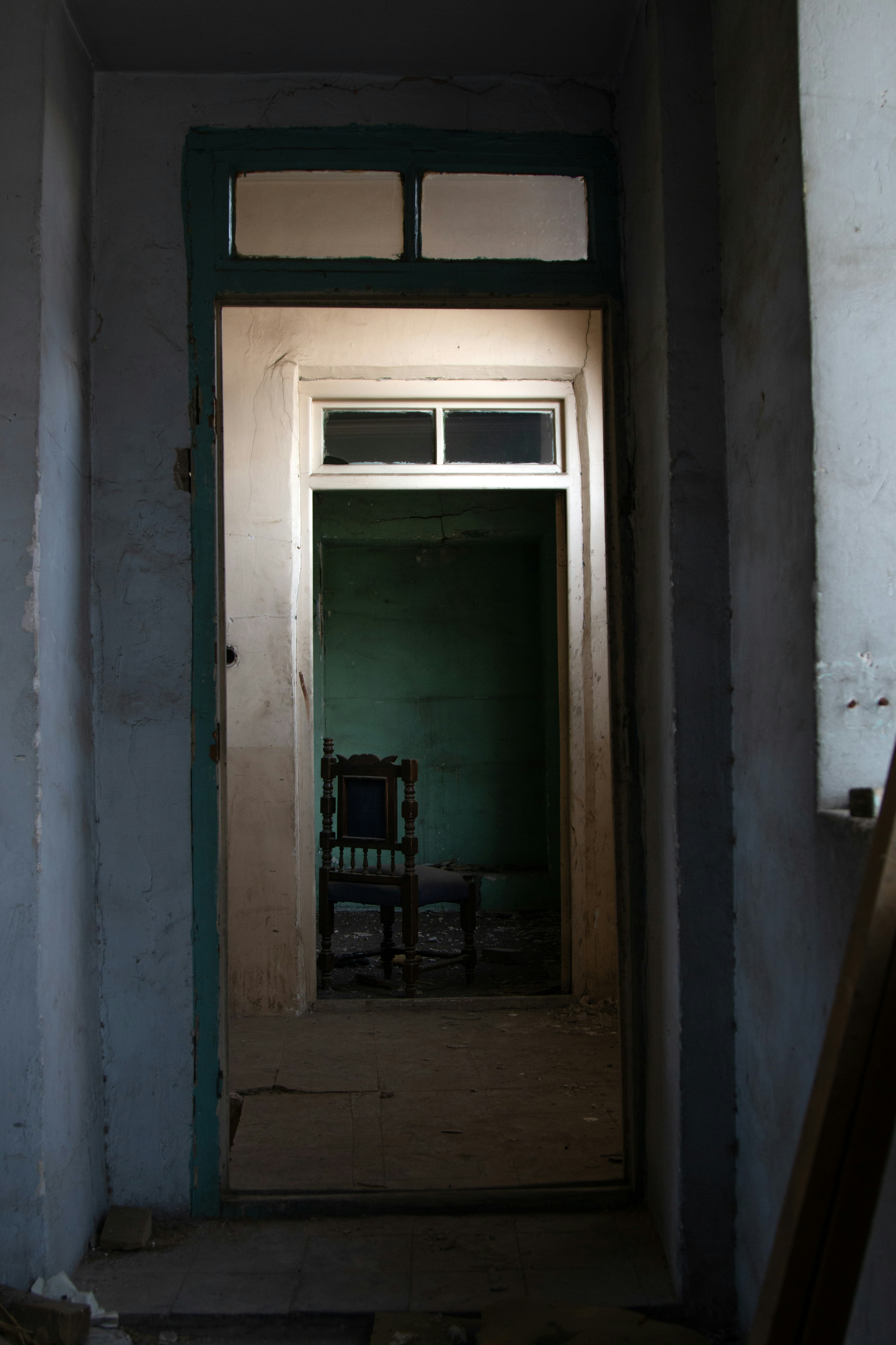 A chair sitting in a doorway of a building photo – Free Tehran province ...