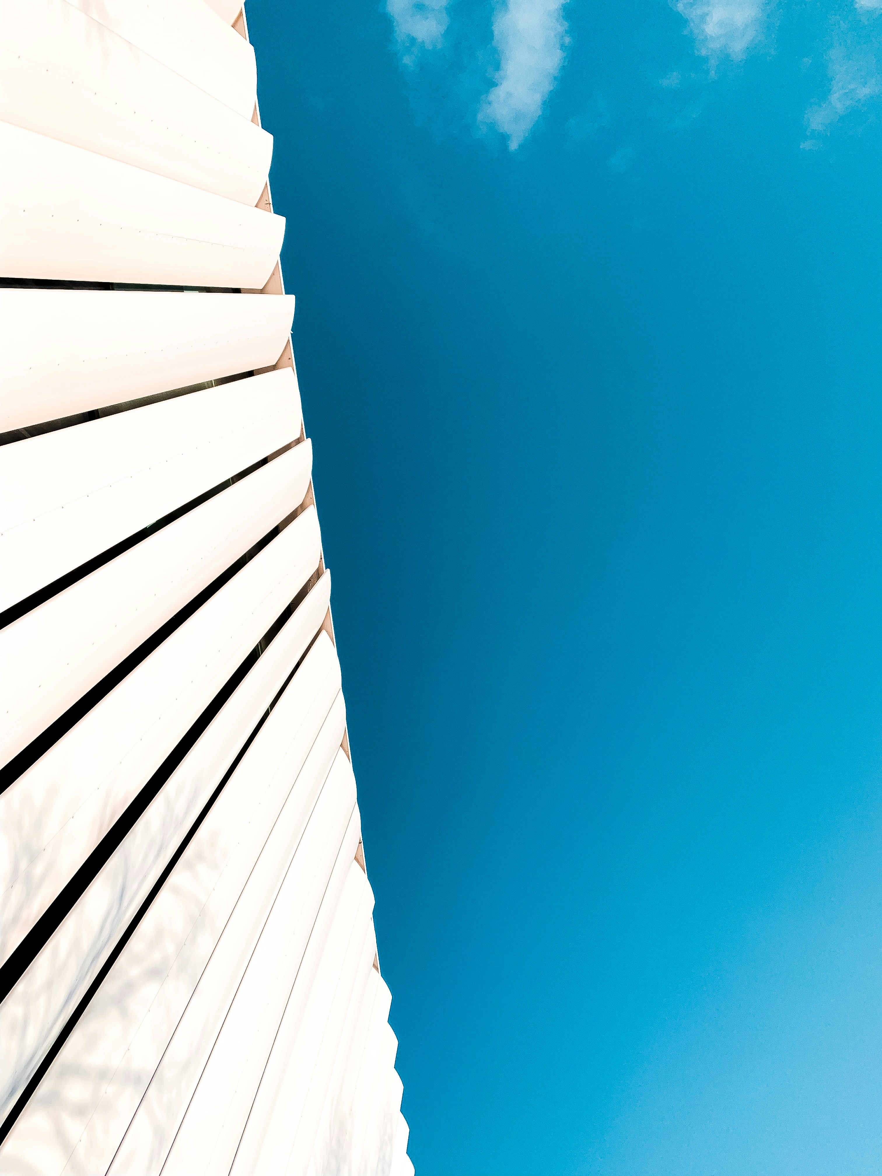 Angular building facade contrasted against a vibrant blue sky.