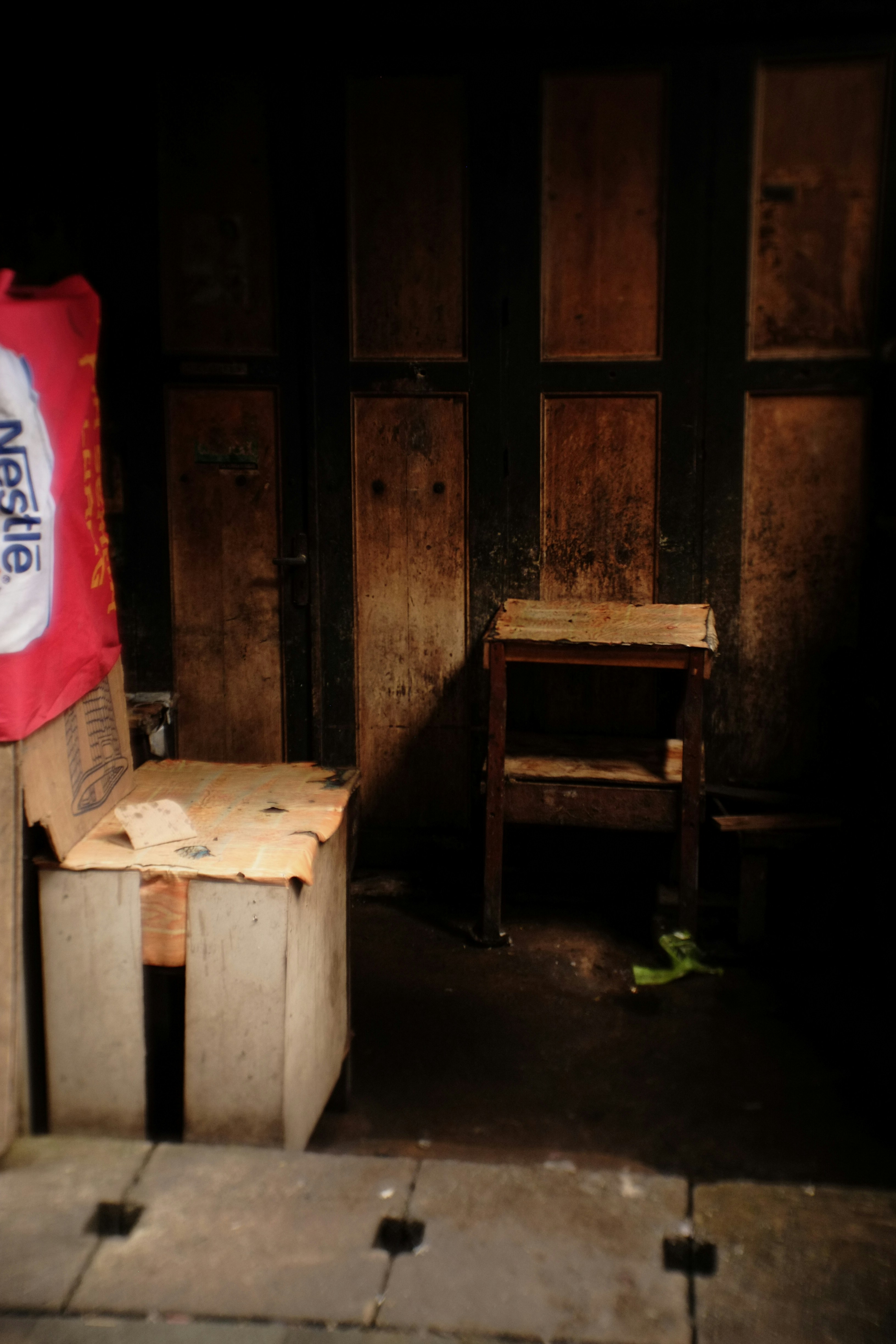 Rust-Streaked Corridor: a Weathered Stool Guards the Shadows