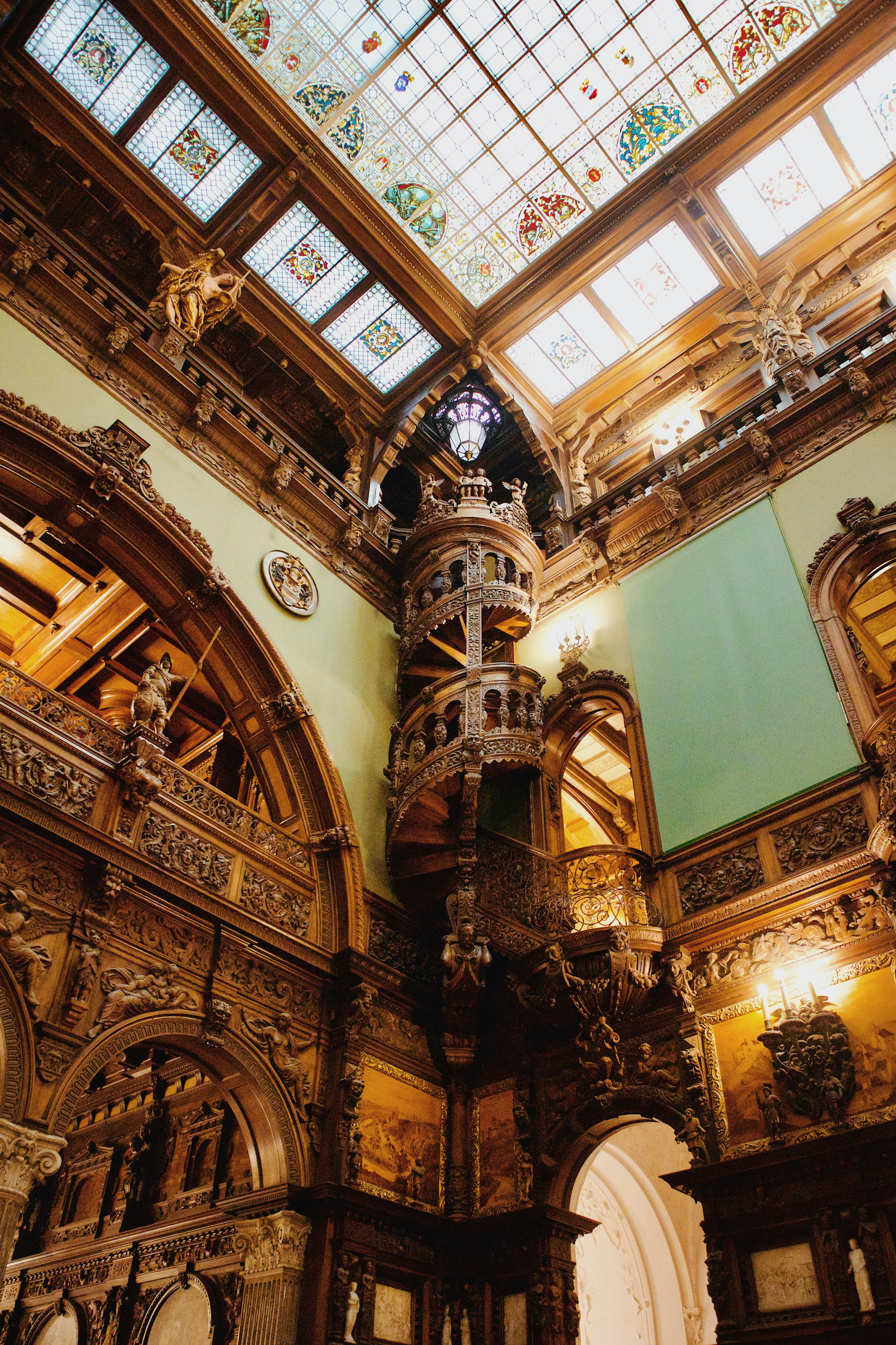 A fancy building with a clock and stained glass ceiling photo – Free ...