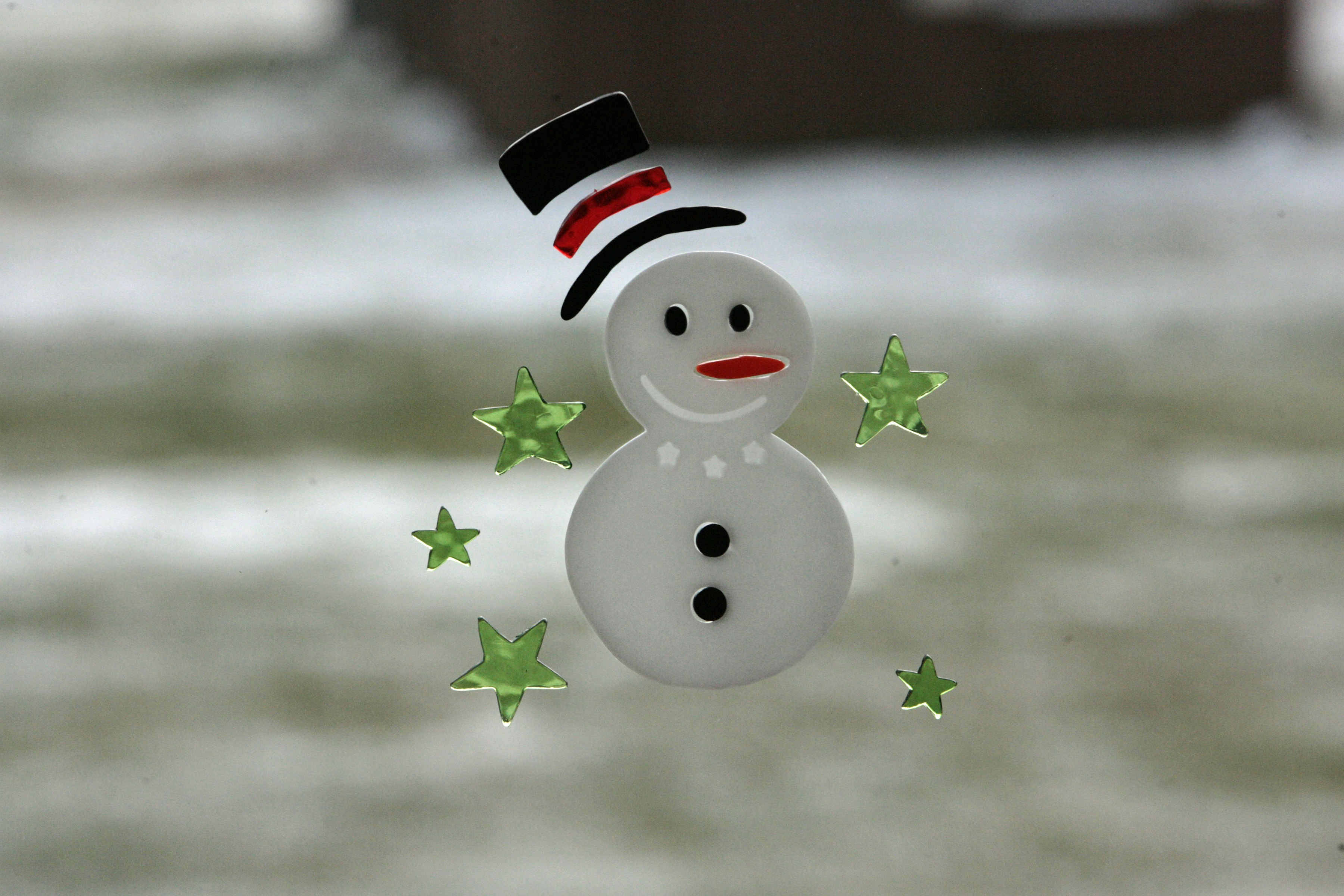 Emerald-Star Snowman on a Frosted Window Pane