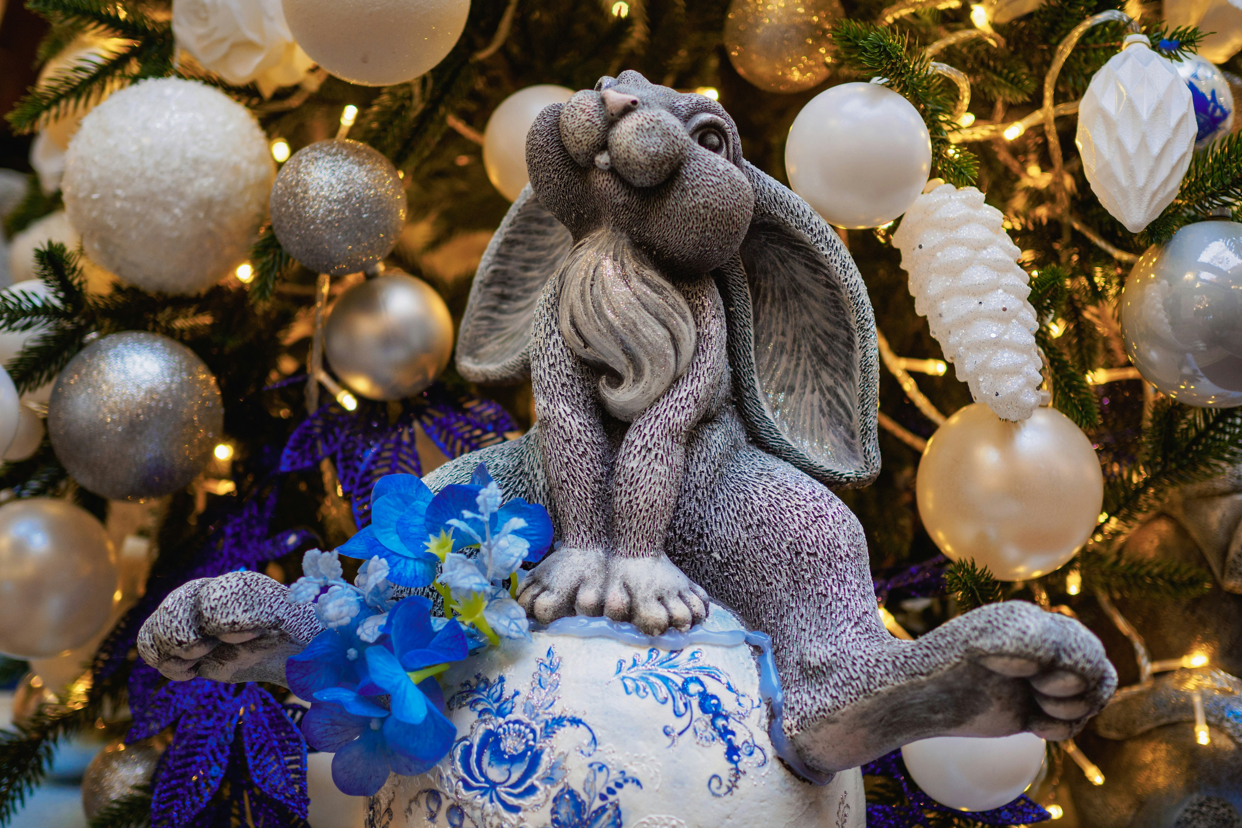 Whimsy Under Ornament Glow: A Gray Statue Among Holiday Orbs