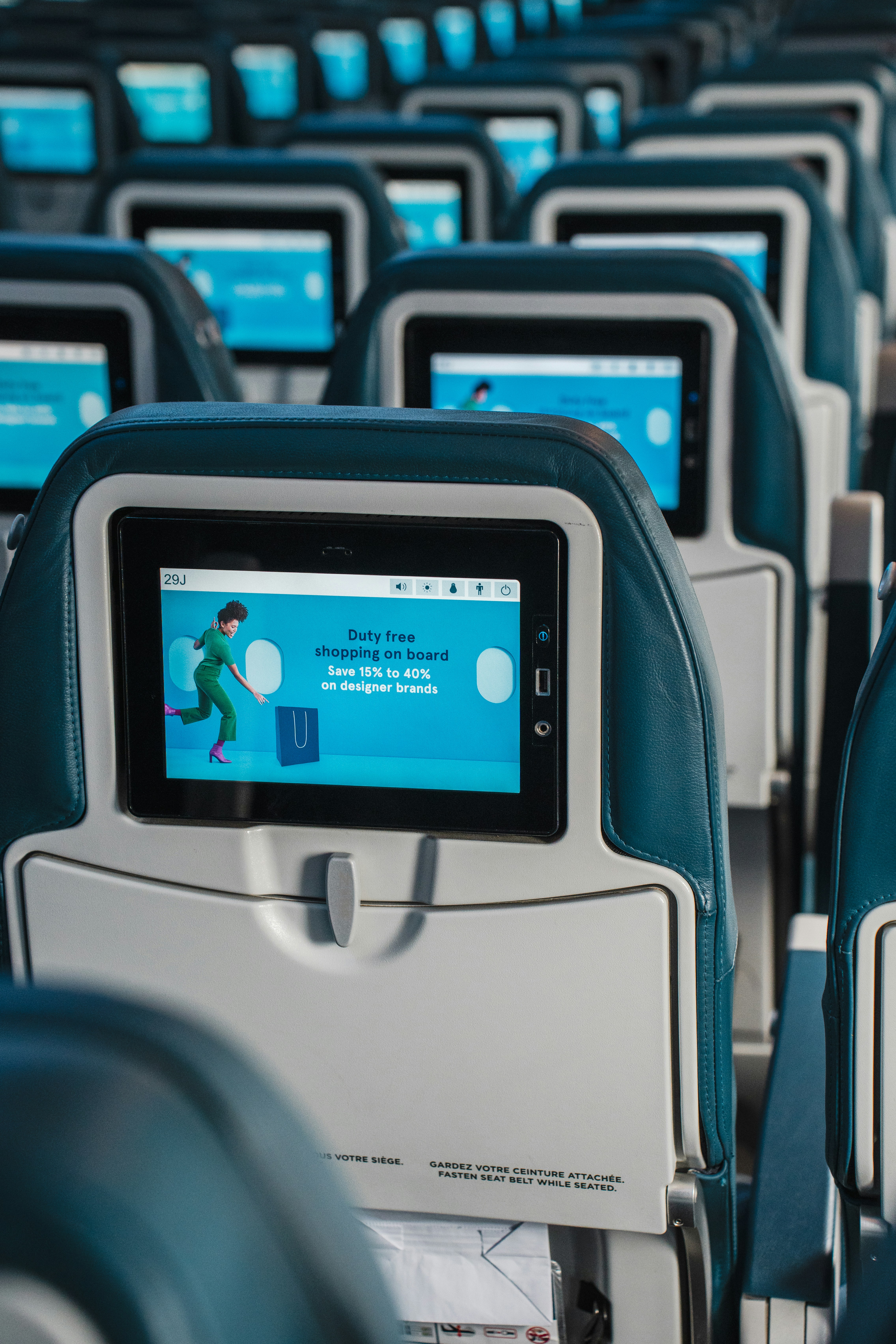 A row of seats with electronic devices on them photo – Free Woman Image ...
