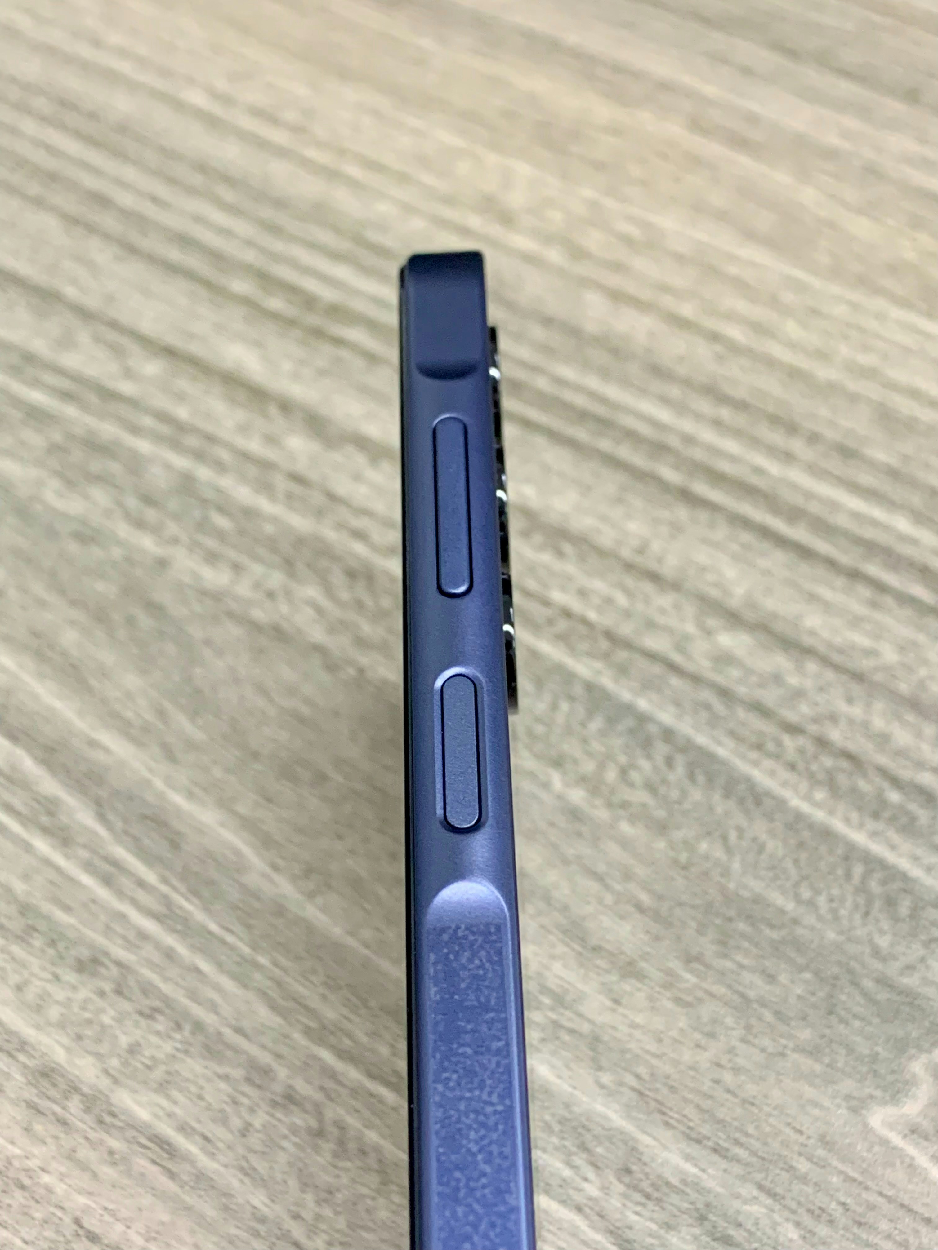 Blue Profile: A Close-Up of a Compact Phone on Wood