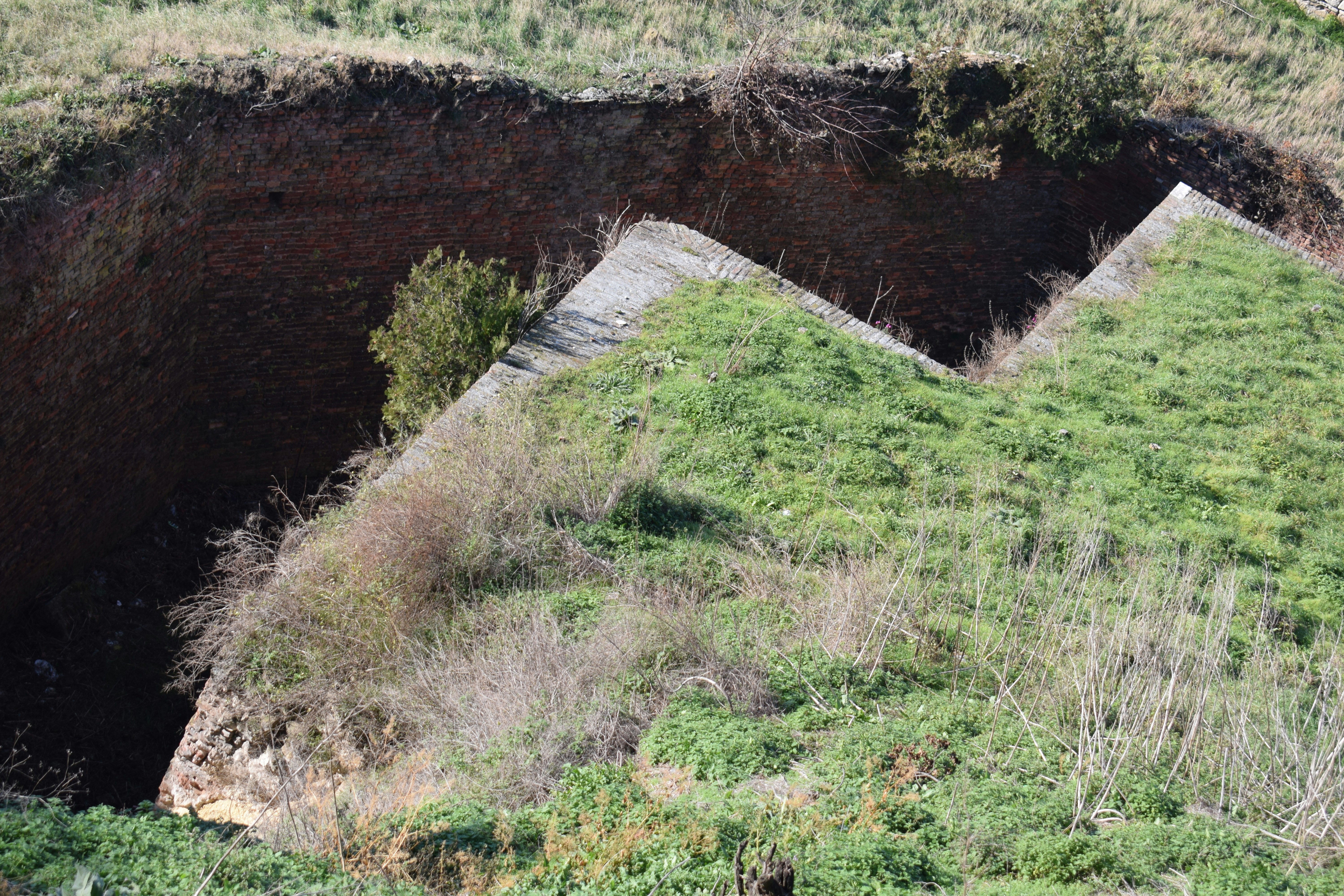 A large open pit in the middle of a field photo – Free Bunker Image on ...