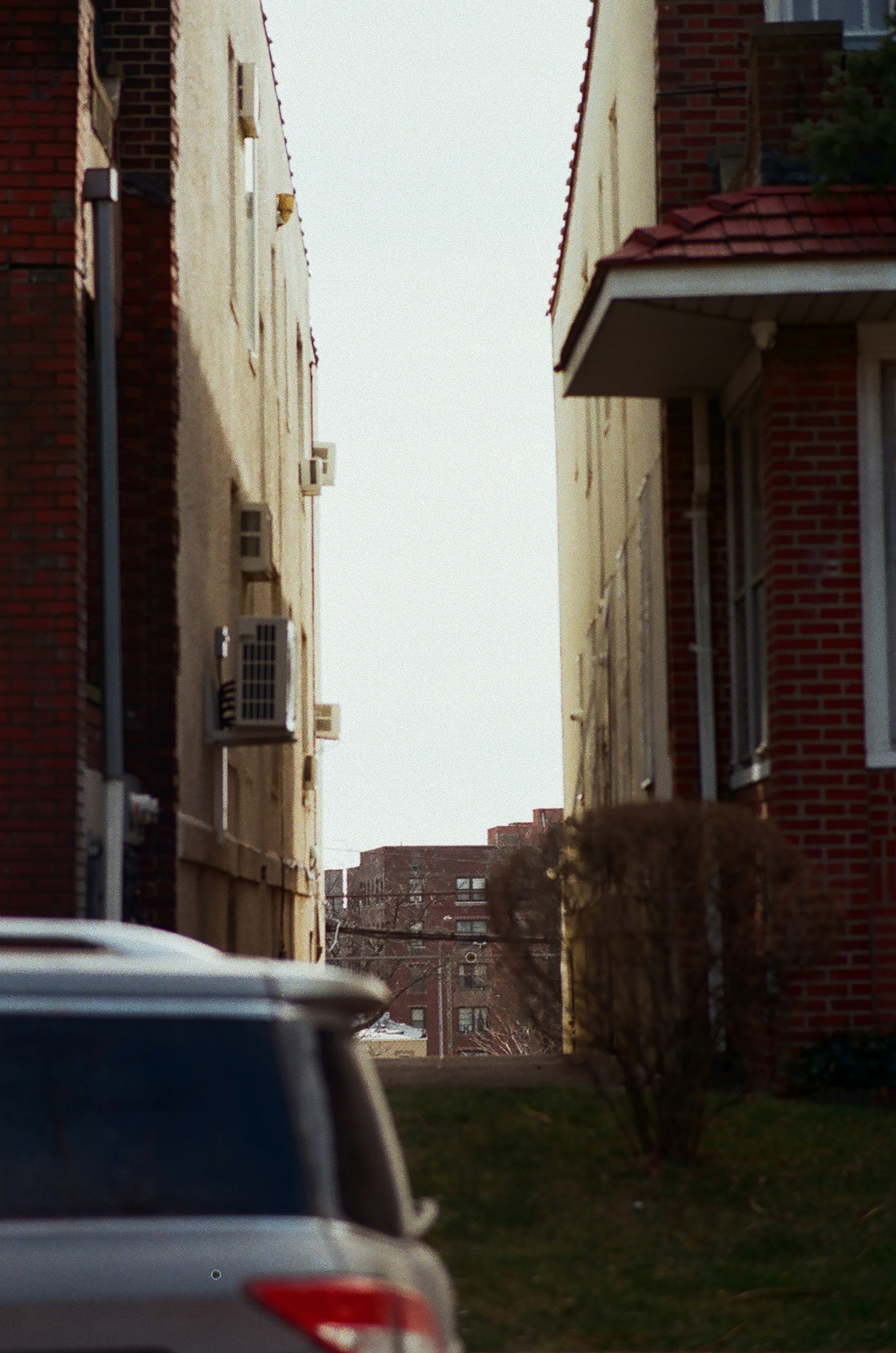 A Narrow Corridor Between Brick Facades