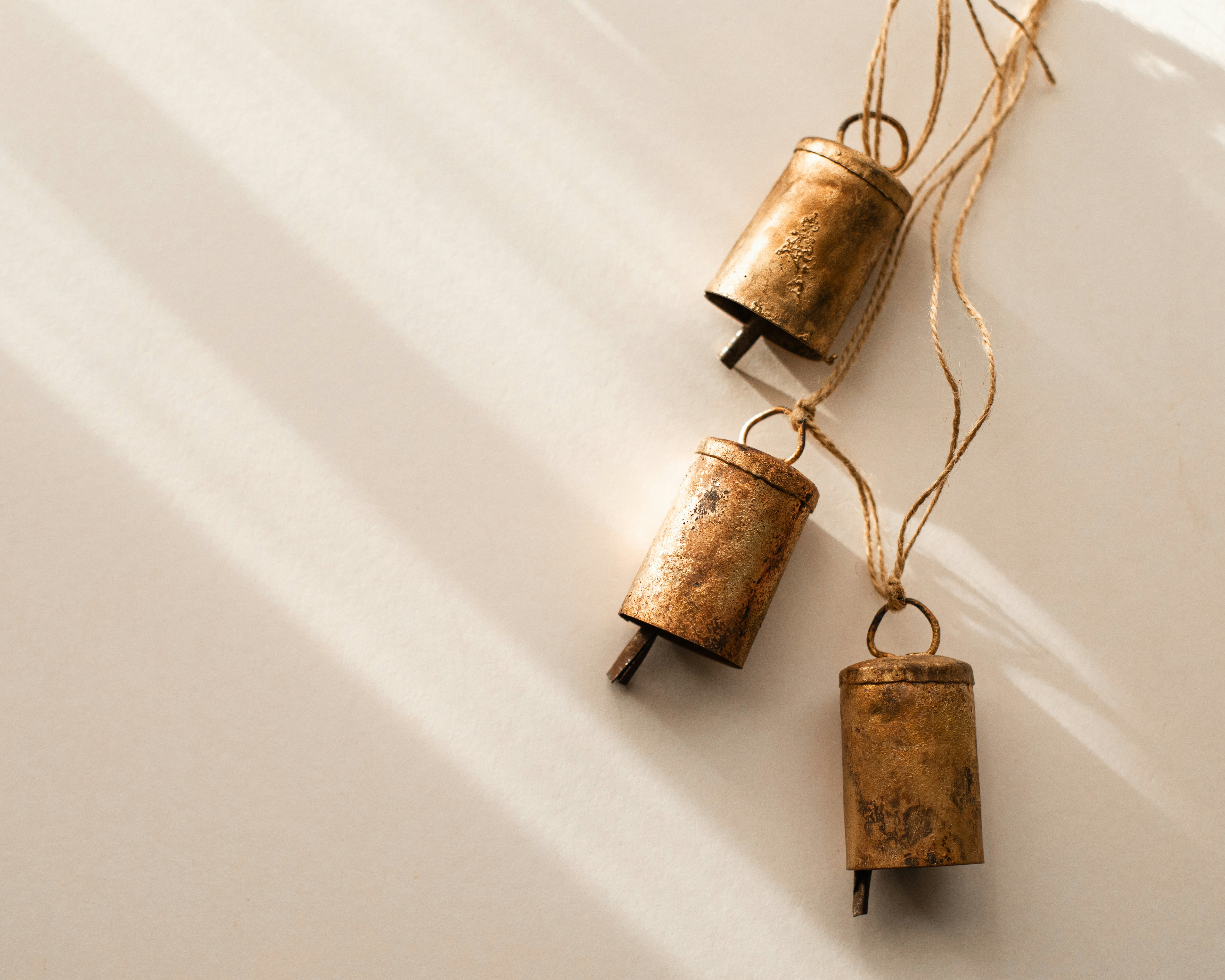 A couple of bells hanging from a string photo – Free Shadows Image on ...