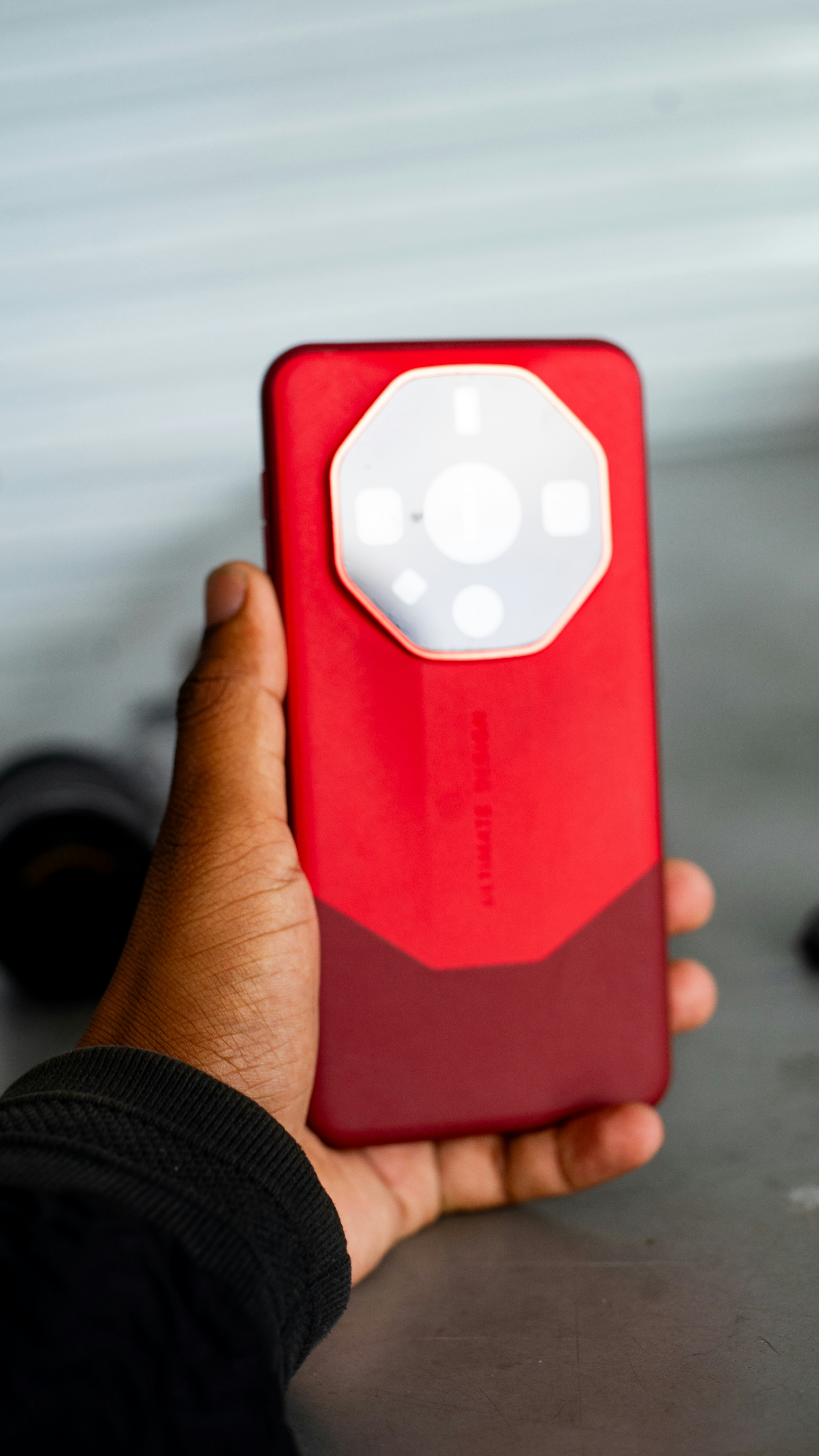 A person holding a red cell phone in their hand photo – Free Phone ...
