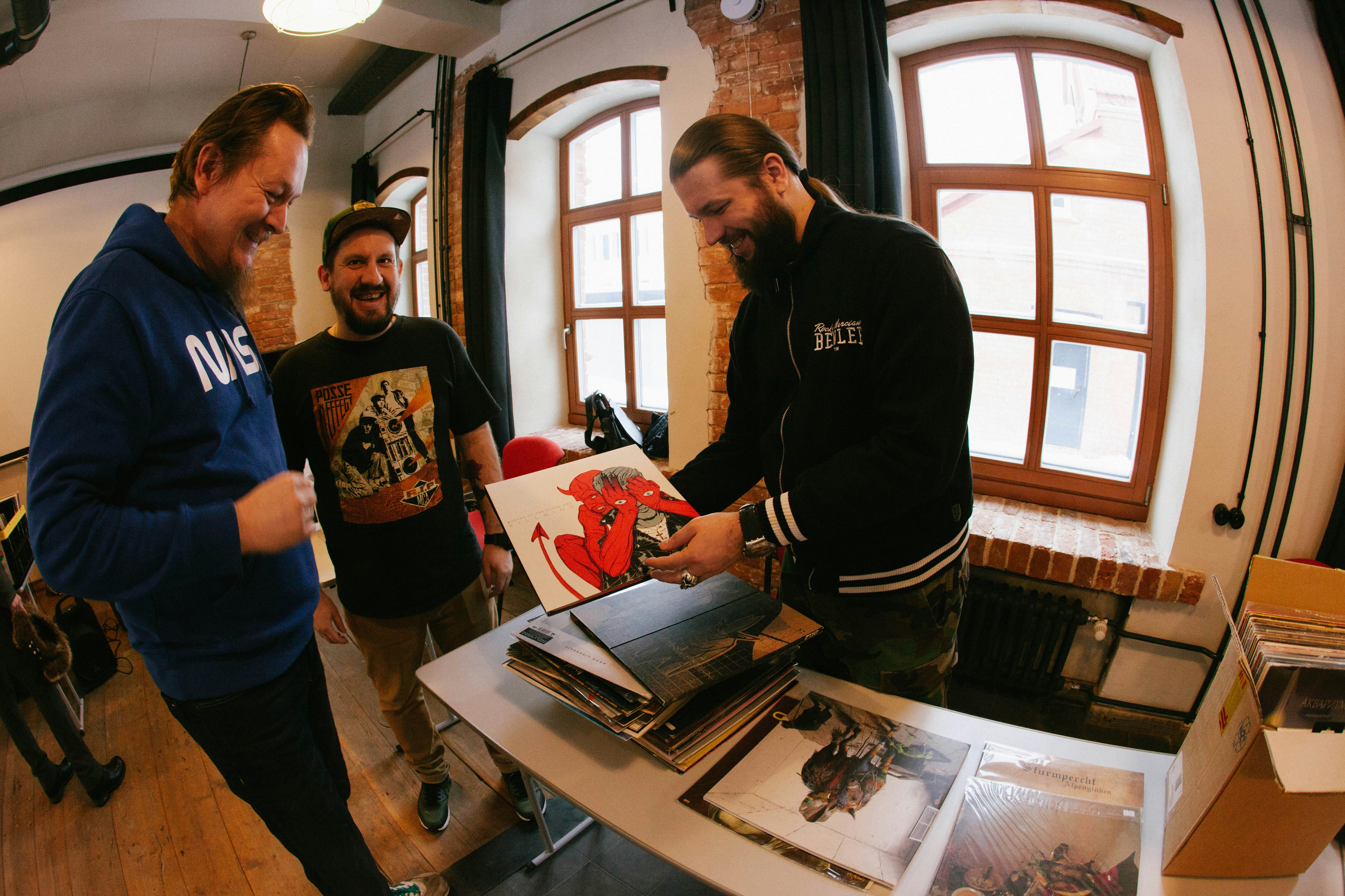 A group of men standing around a table photo – Free Vynil Image on Unsplash
