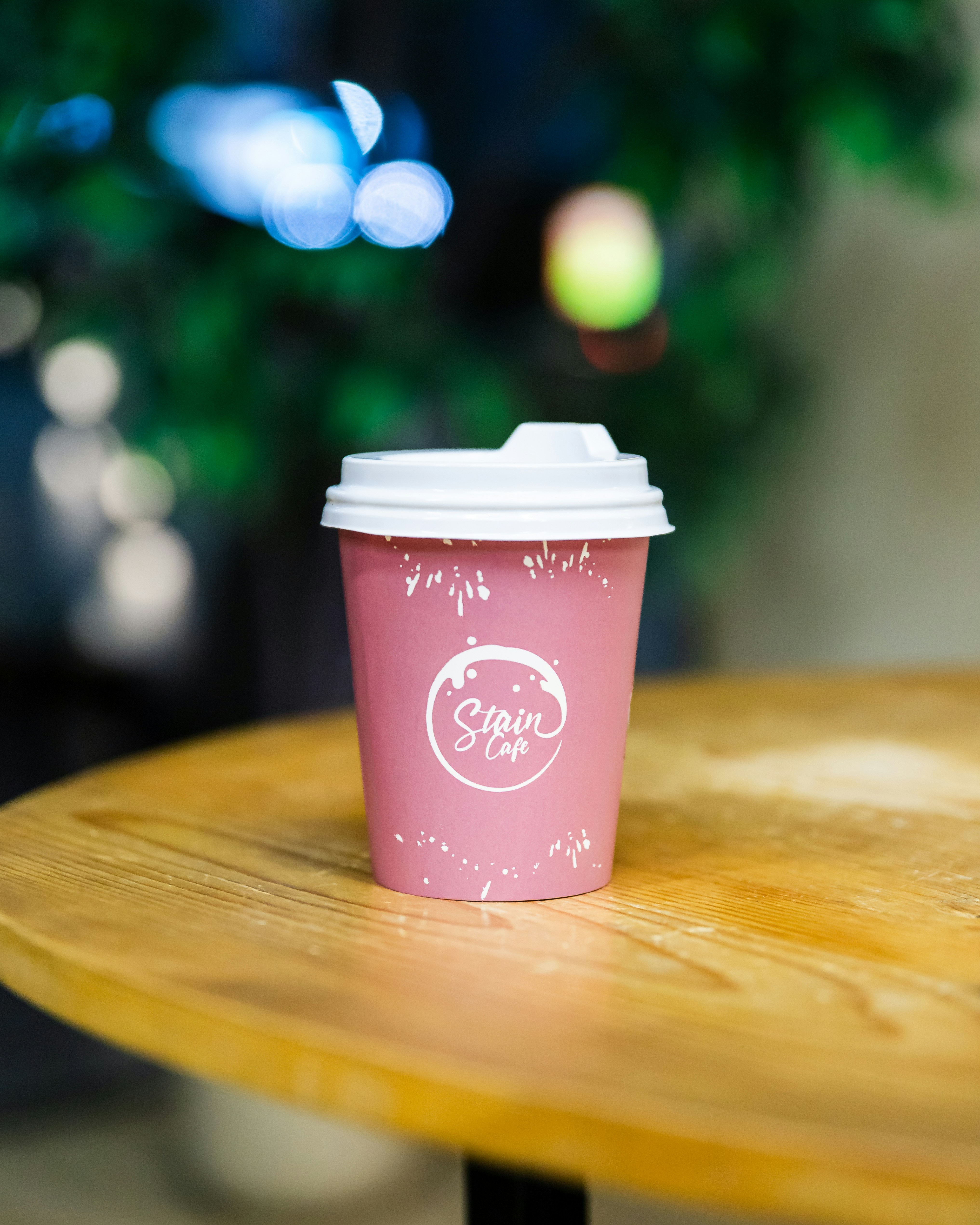 Pink Cup on a Warm Wood Table at a Cozy Café