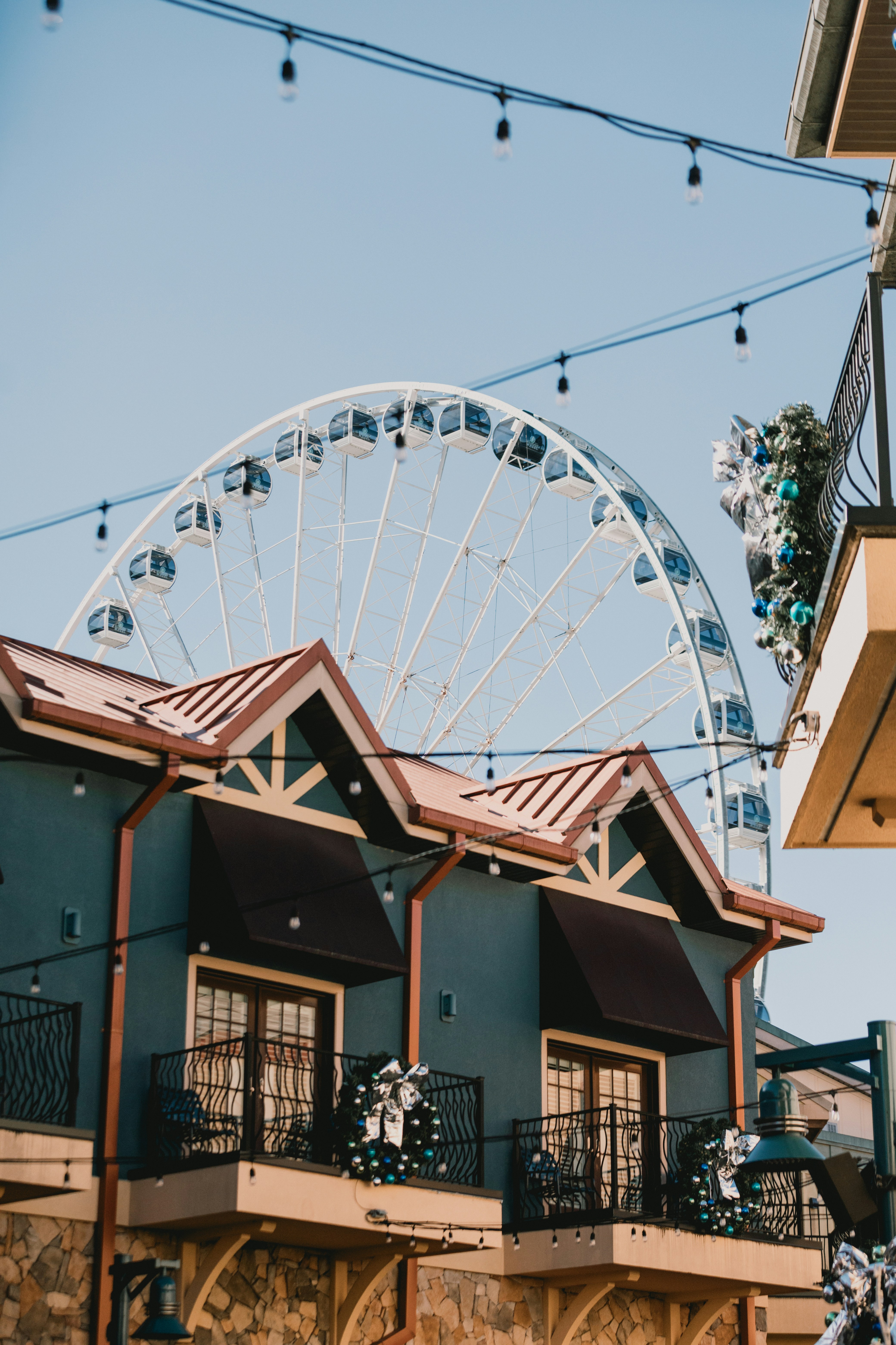 A building with a ferris wheel in the background photo – Free Ferris ...