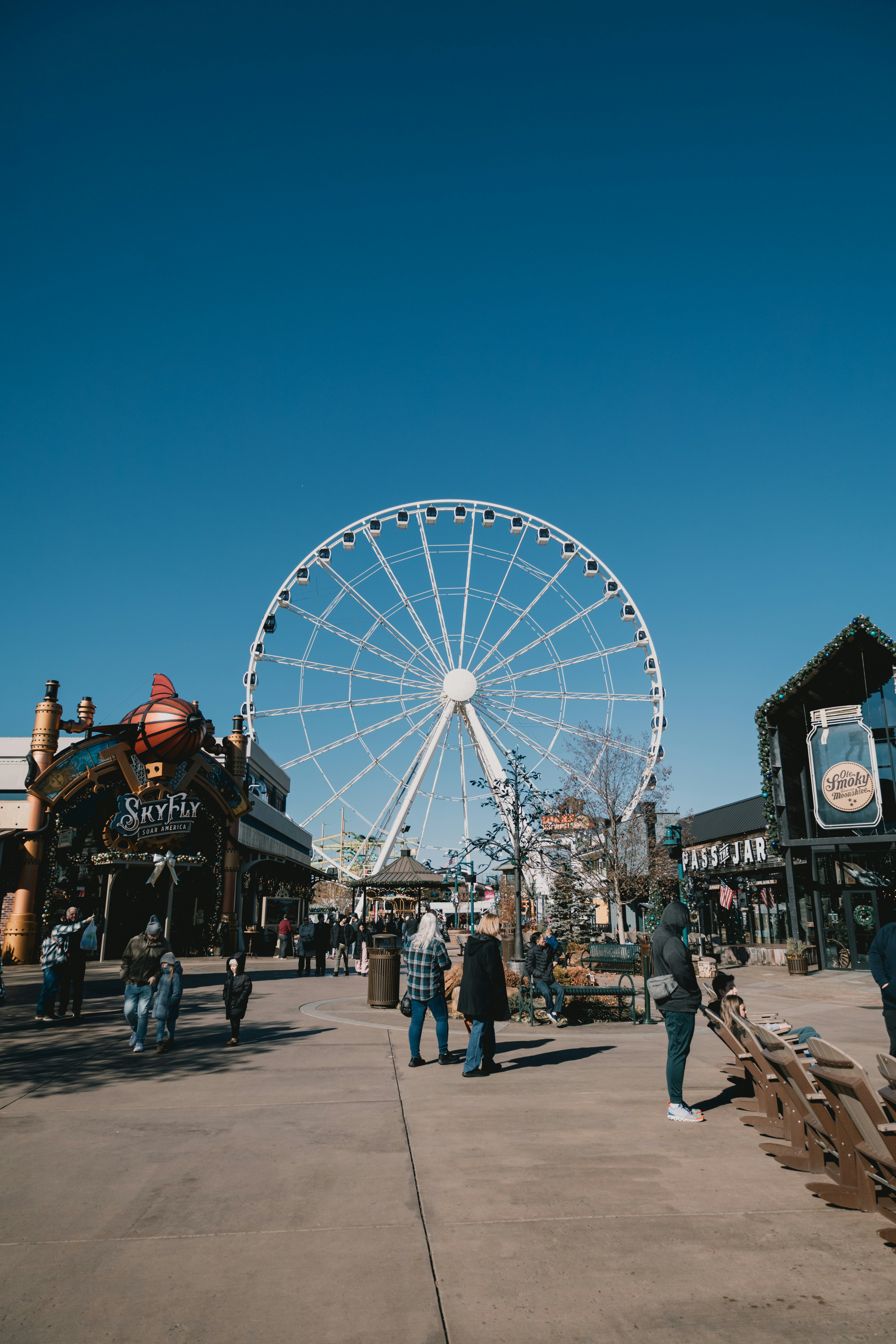 A large ferris wheel sitting next to a building photo – Free Ferris ...