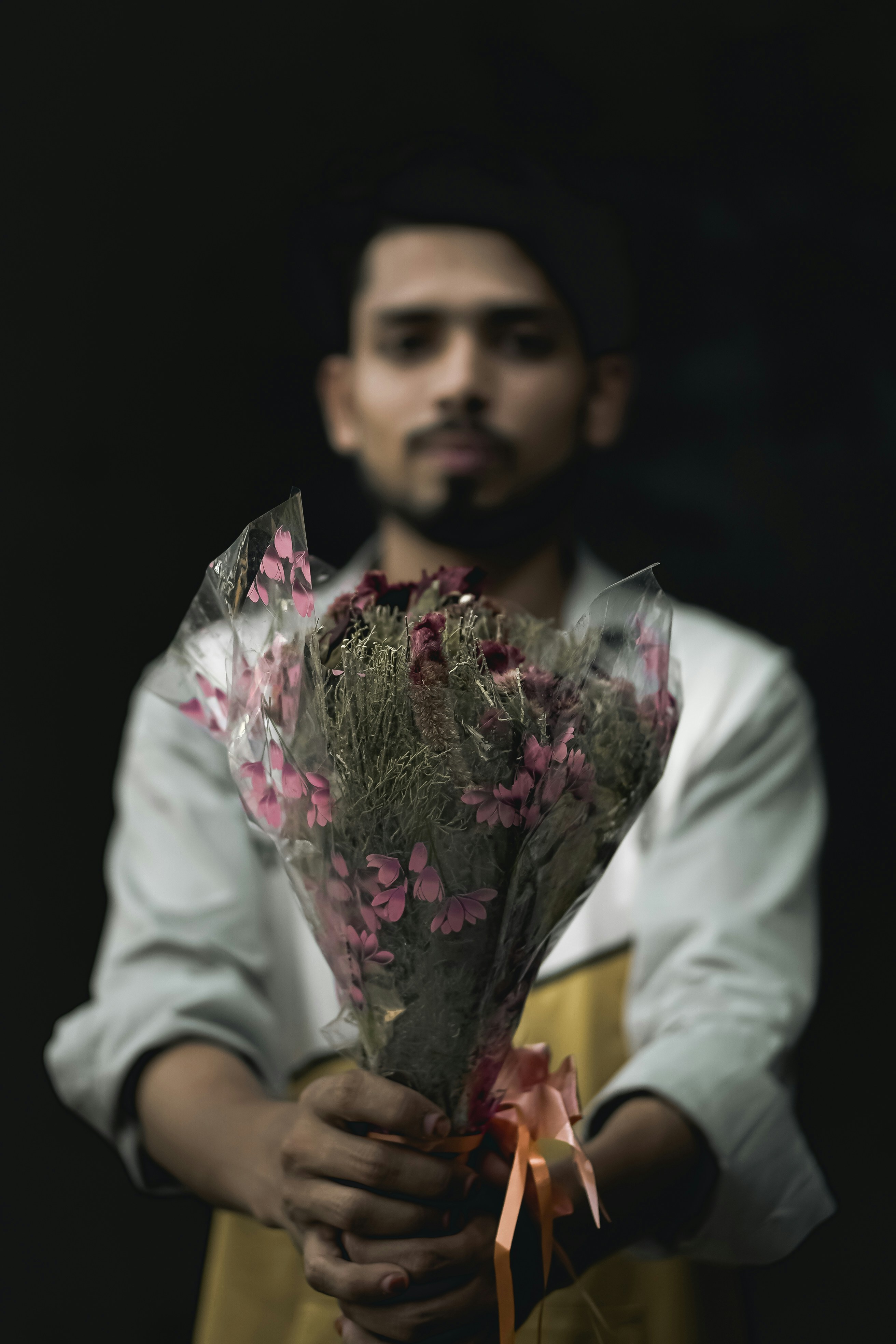 Petal Promise: A Bouquet in Sharp Focus Against a Velvet-Blurred Portrait