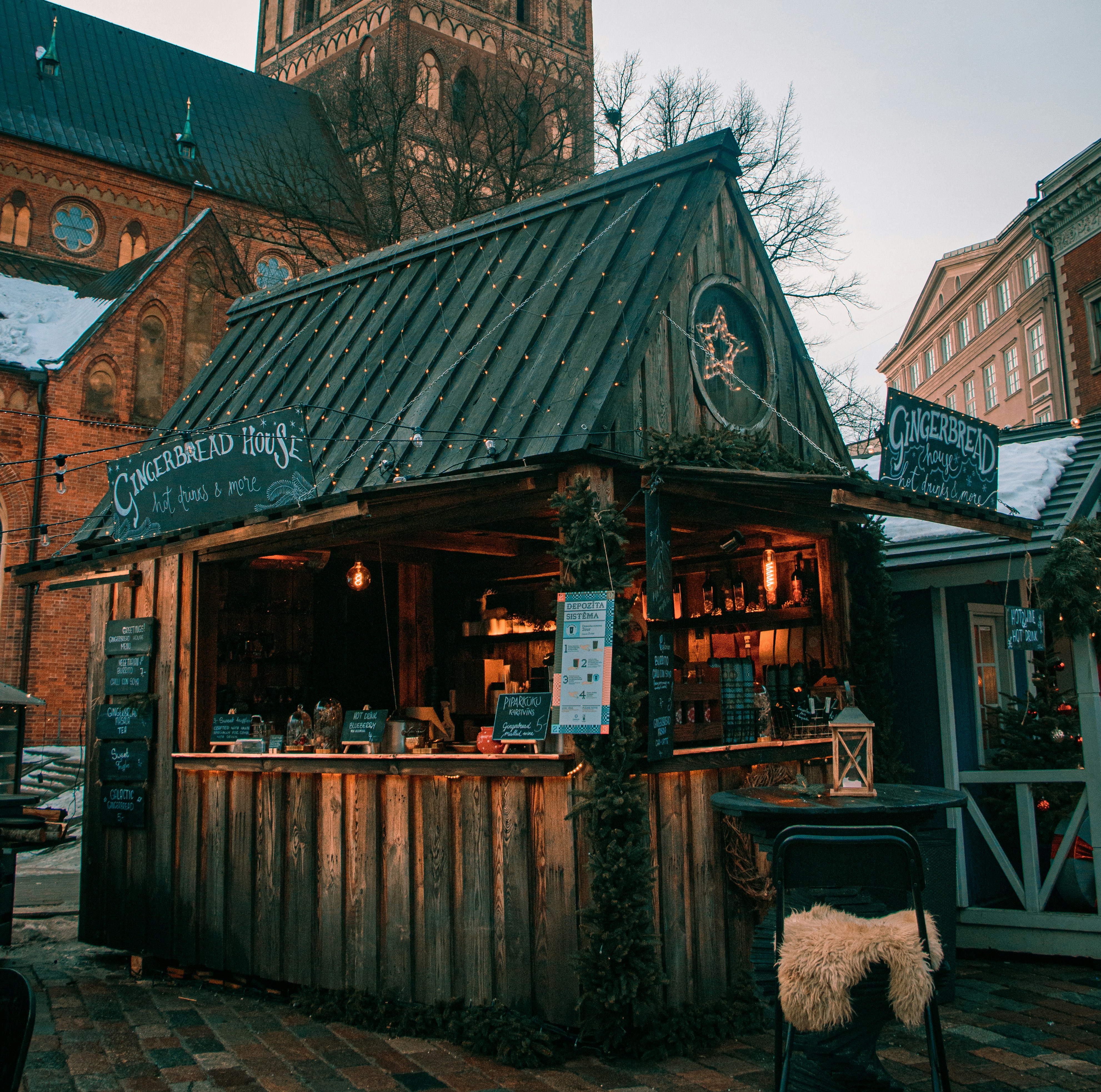 Gingerbread Glow: Cozy Stall Amid Historic Brick Facades