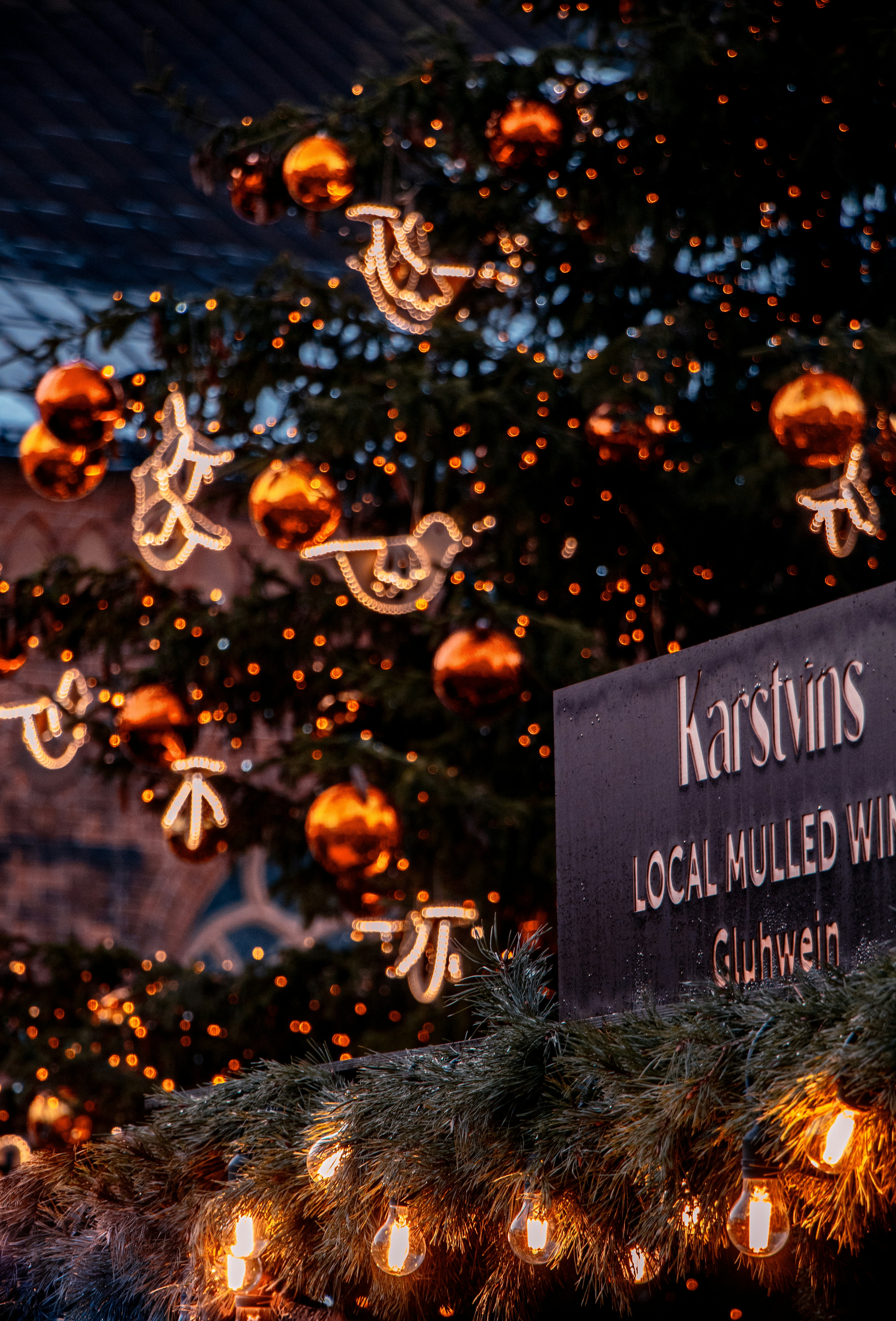 Glowing Orbs Above a Festive Sign