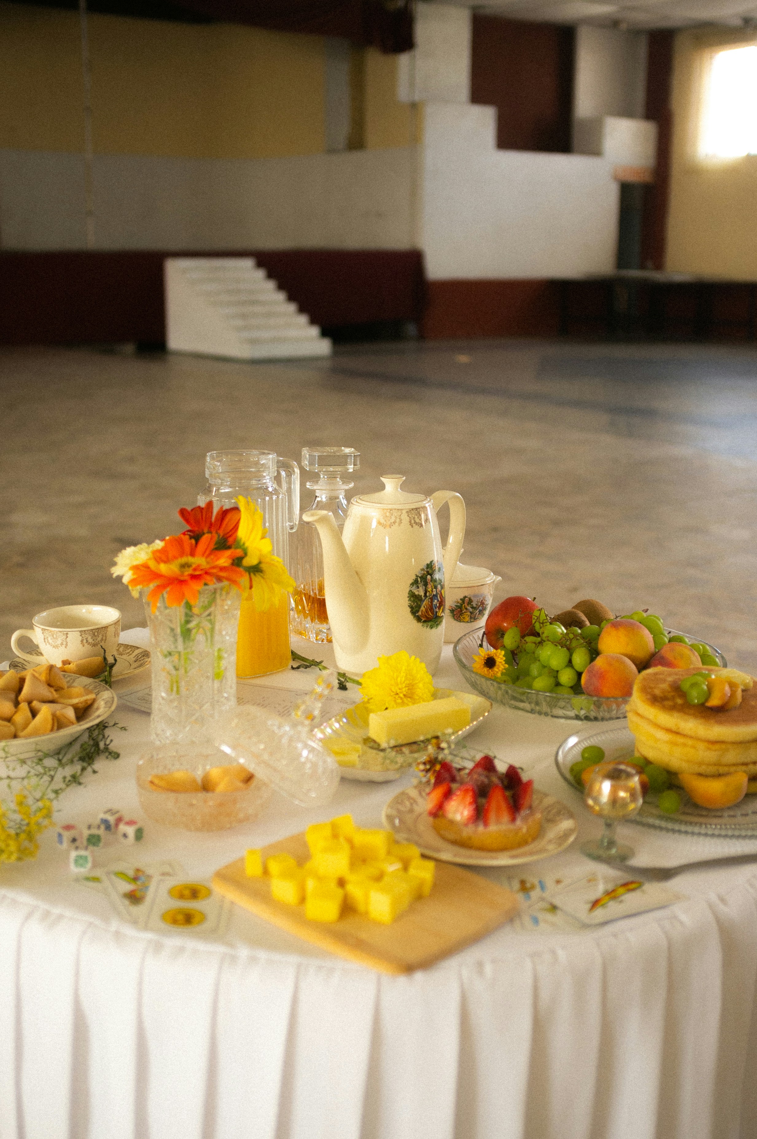 Sunlit Tableaux: Petals, Porcelain, and Fruit in an Empty Auditorium