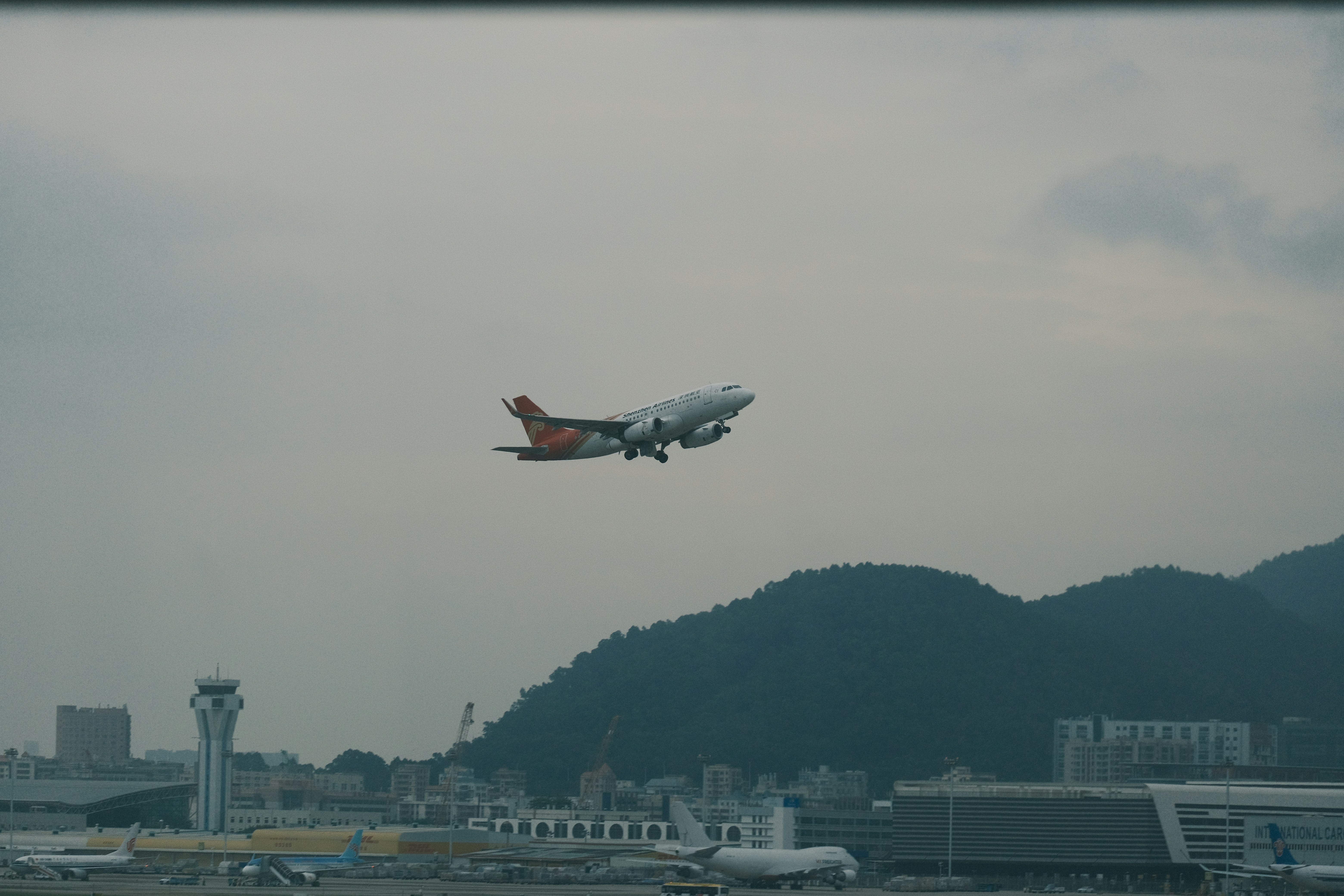 a large passenger jet flying through a cloudy sky