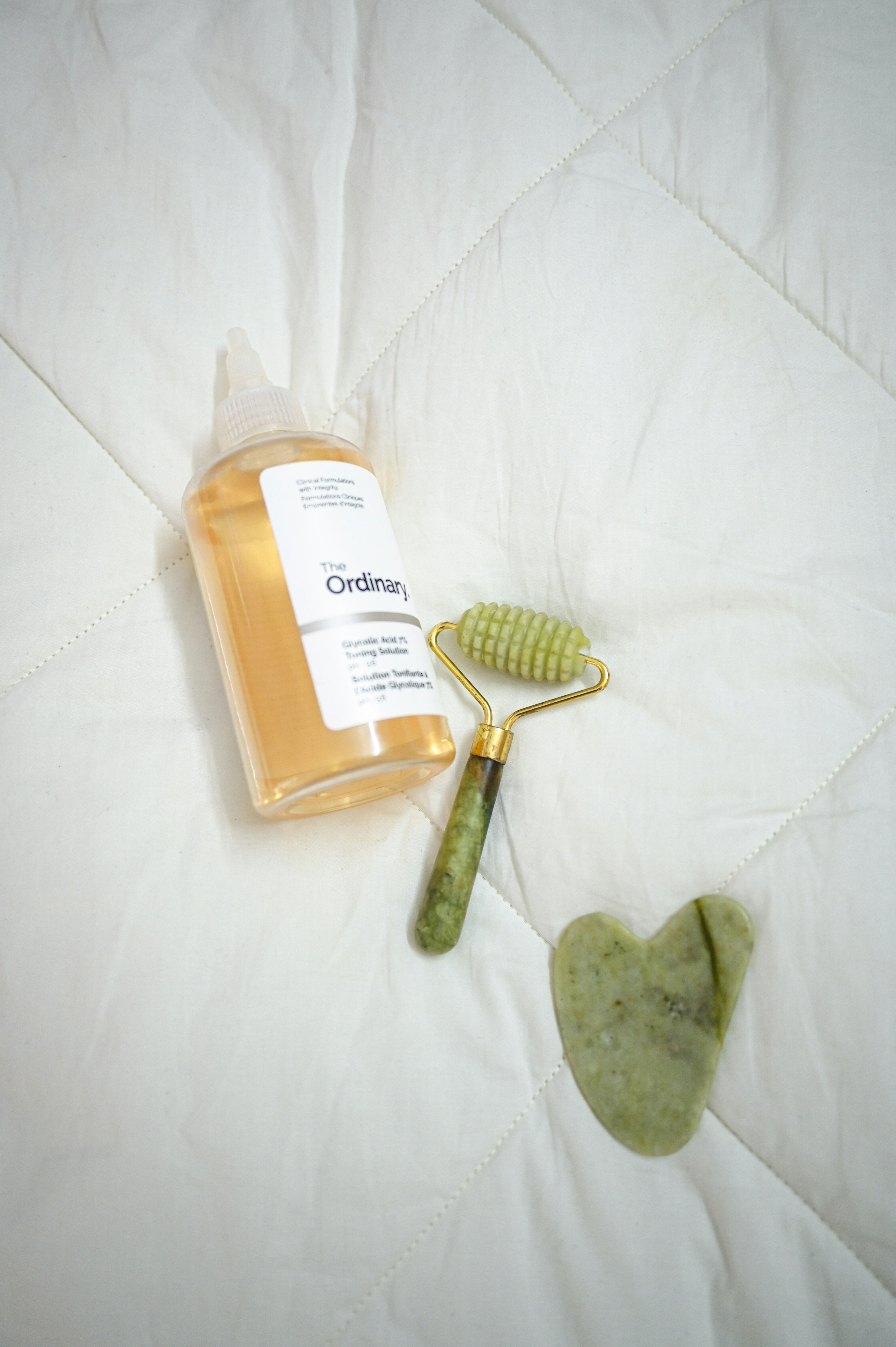 Skincare and Jade: A Quiet Morning on a Quilted Bed