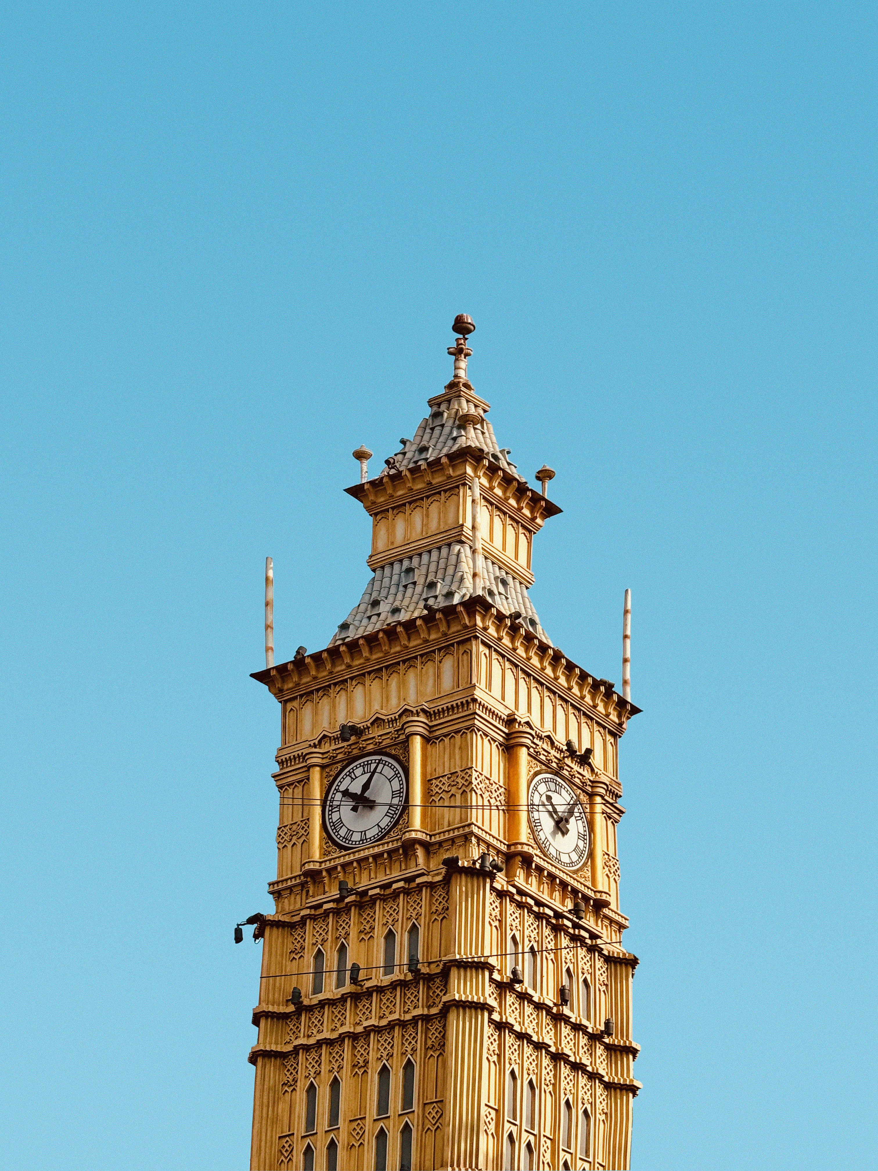 Gilded Clock Tower Against a Pristine Blue Sky