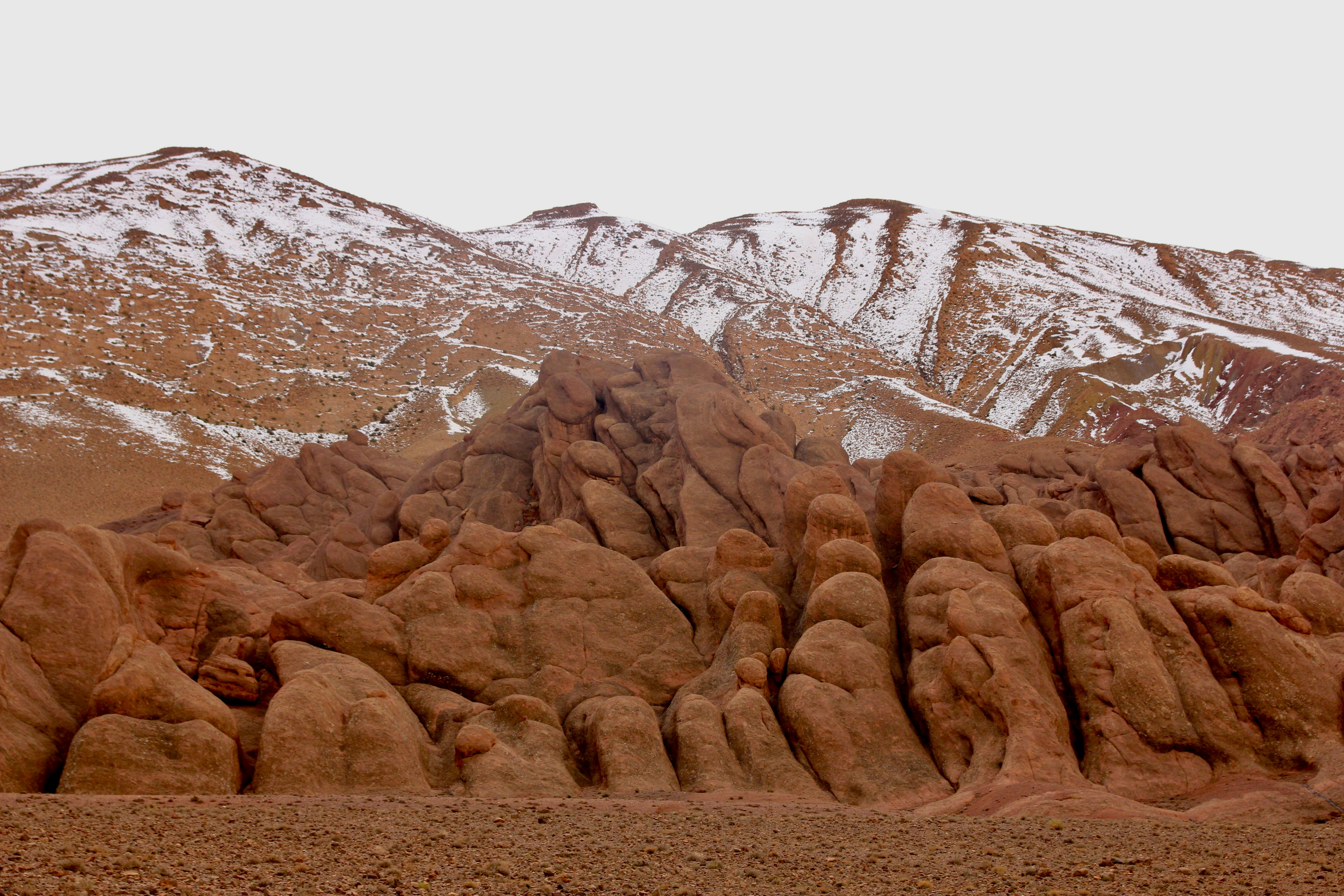 Stone Choir: Erosion Lines Reaching Toward Snow-Kissed Ridges