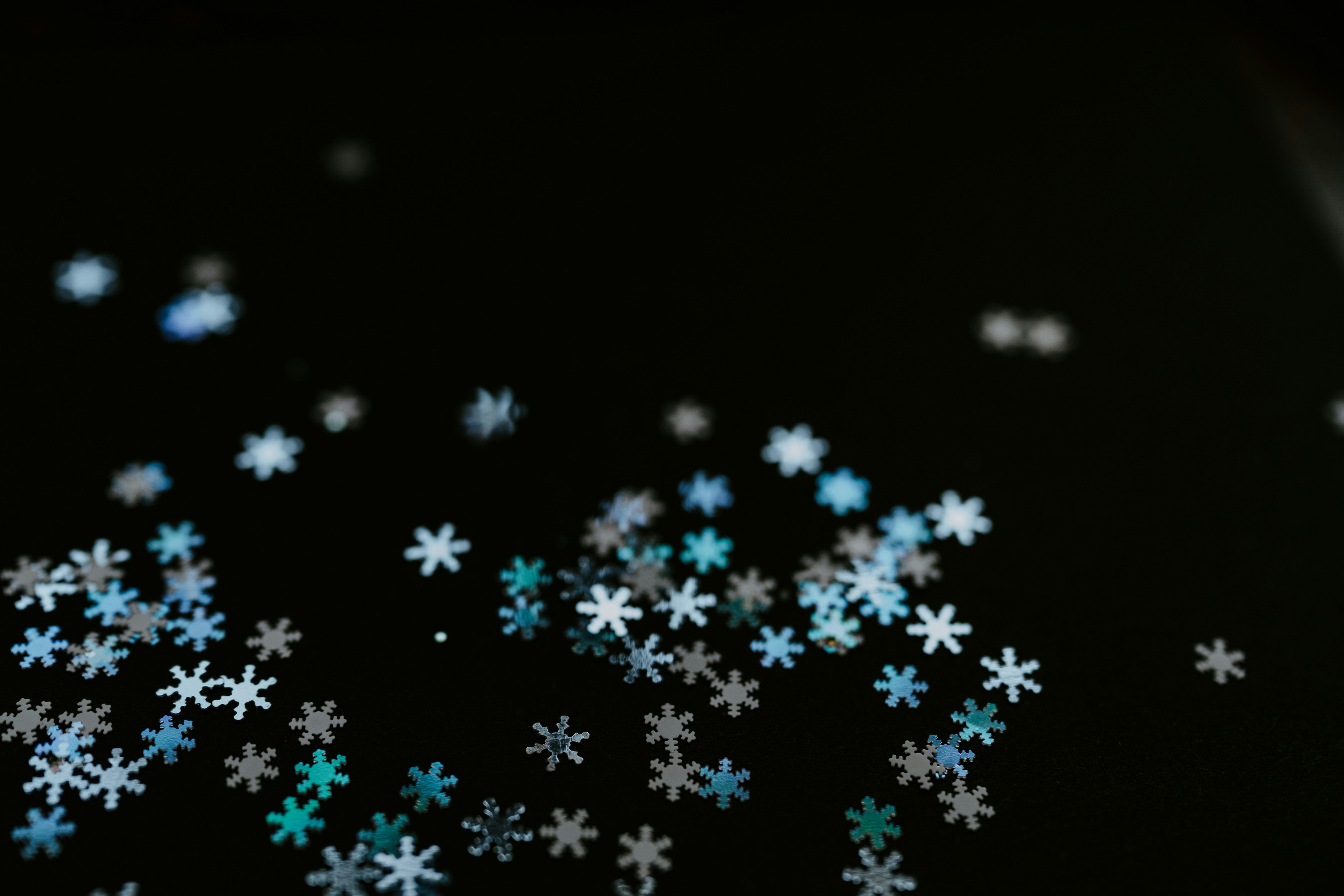 A bunch of snow flakes on a black surface photo – Free Snowflake Image ...