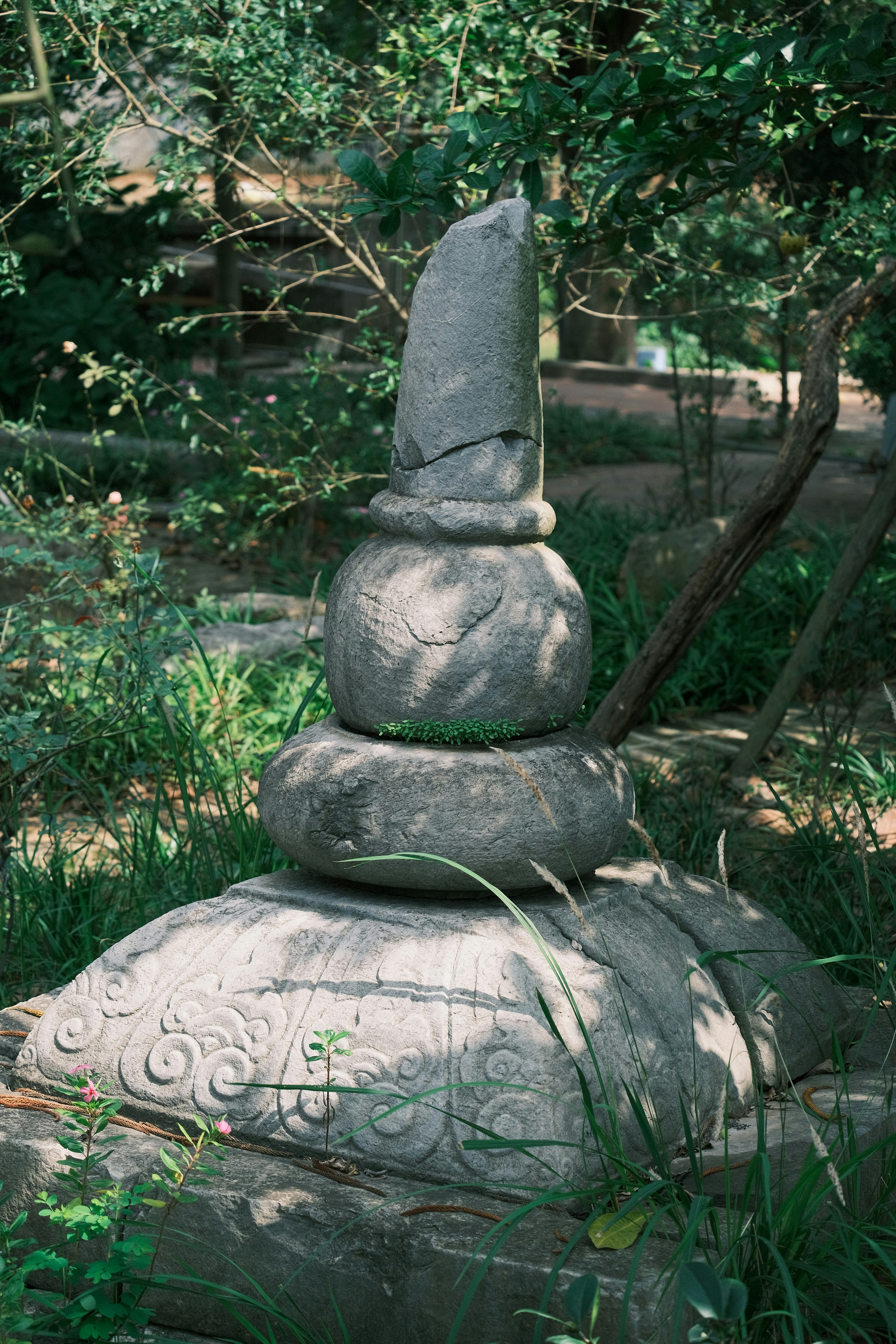 Verdant Silence: A Tiered Stone Stupa Emerges in a Sunlit Garden
