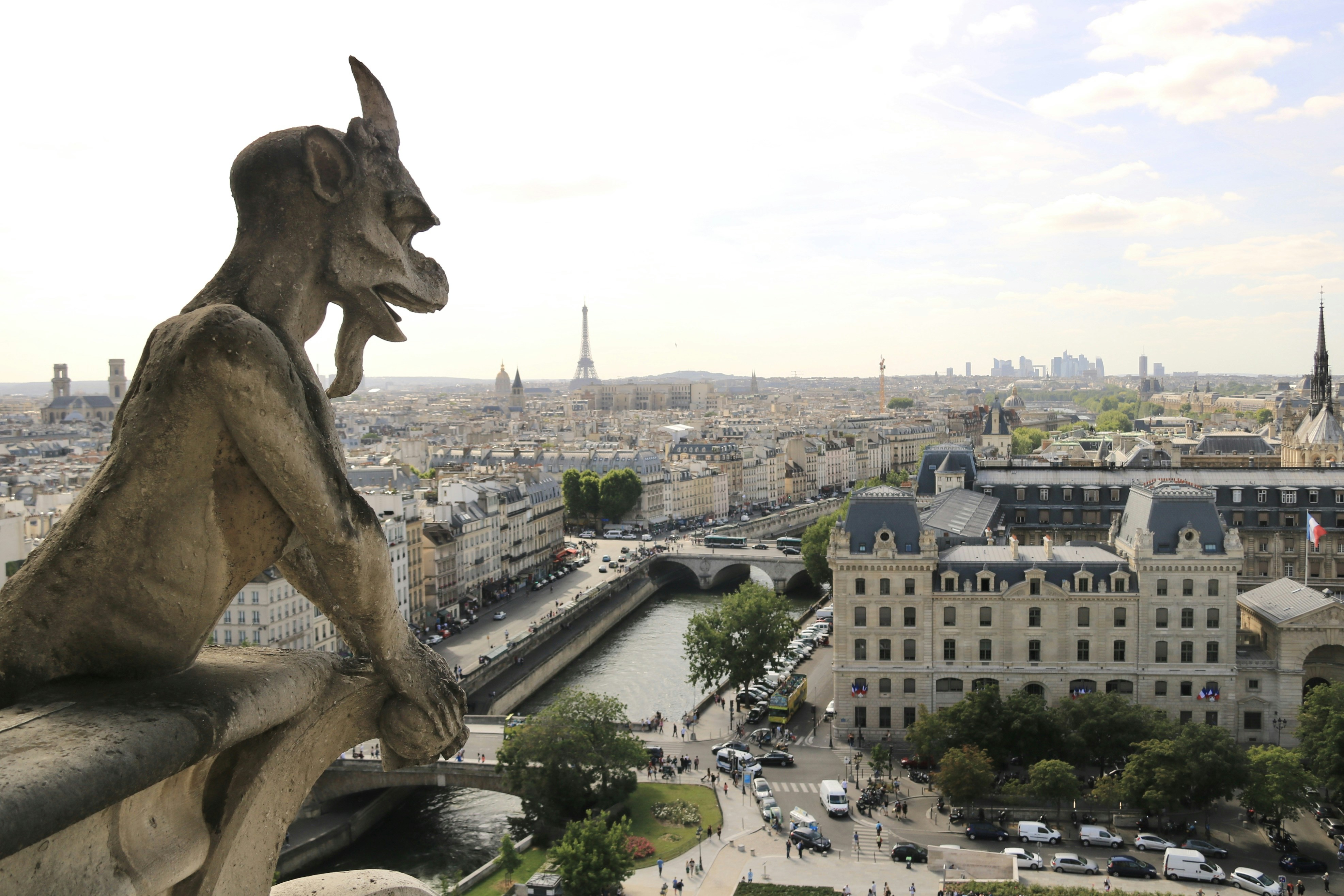 A gargoyle gargoyle on top of a building overlooking a city photo – Free Paris Image on Unsplash