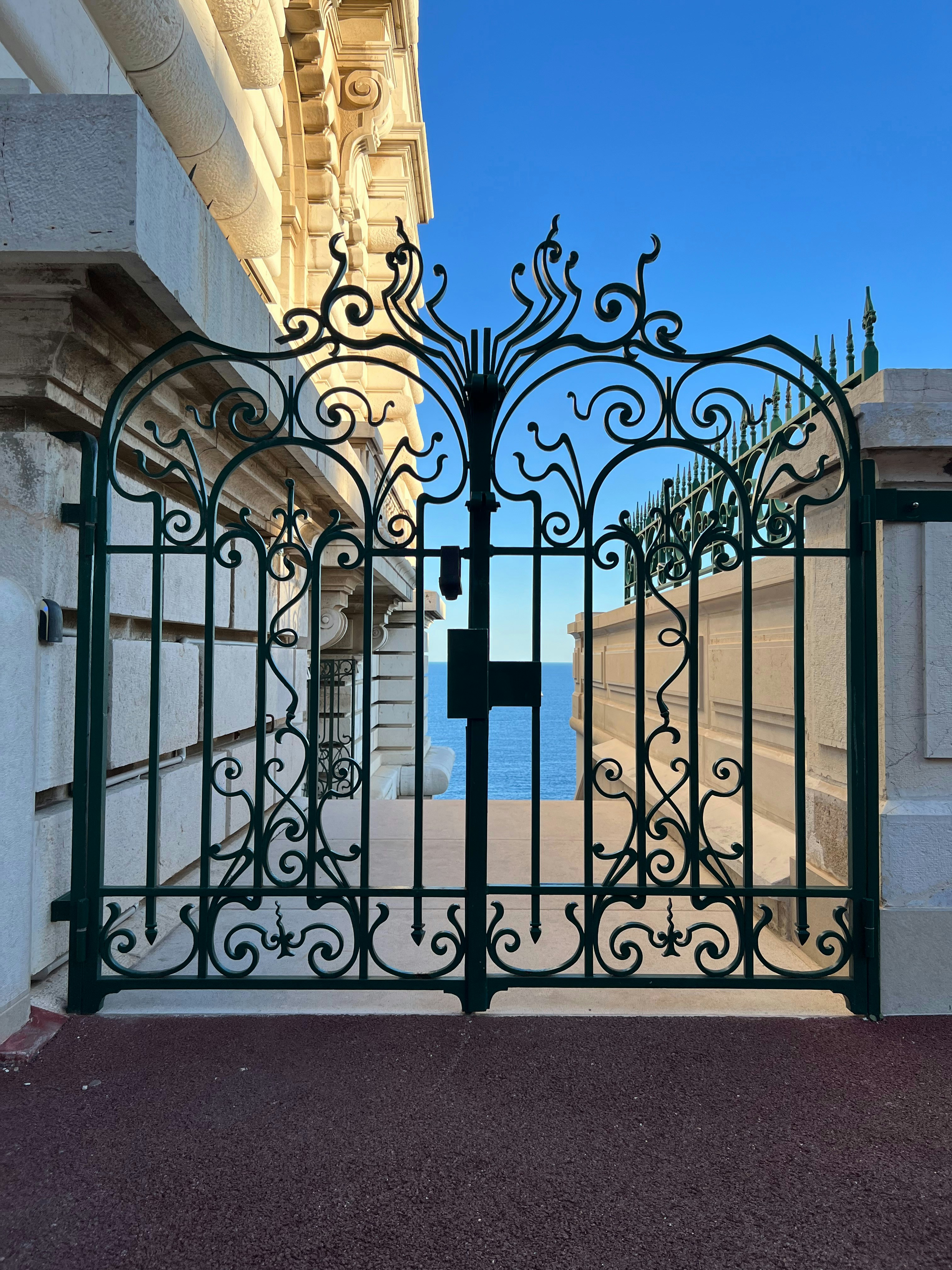 Ironwork Gate to the Sea: A Portal Framed by Stone and Sky