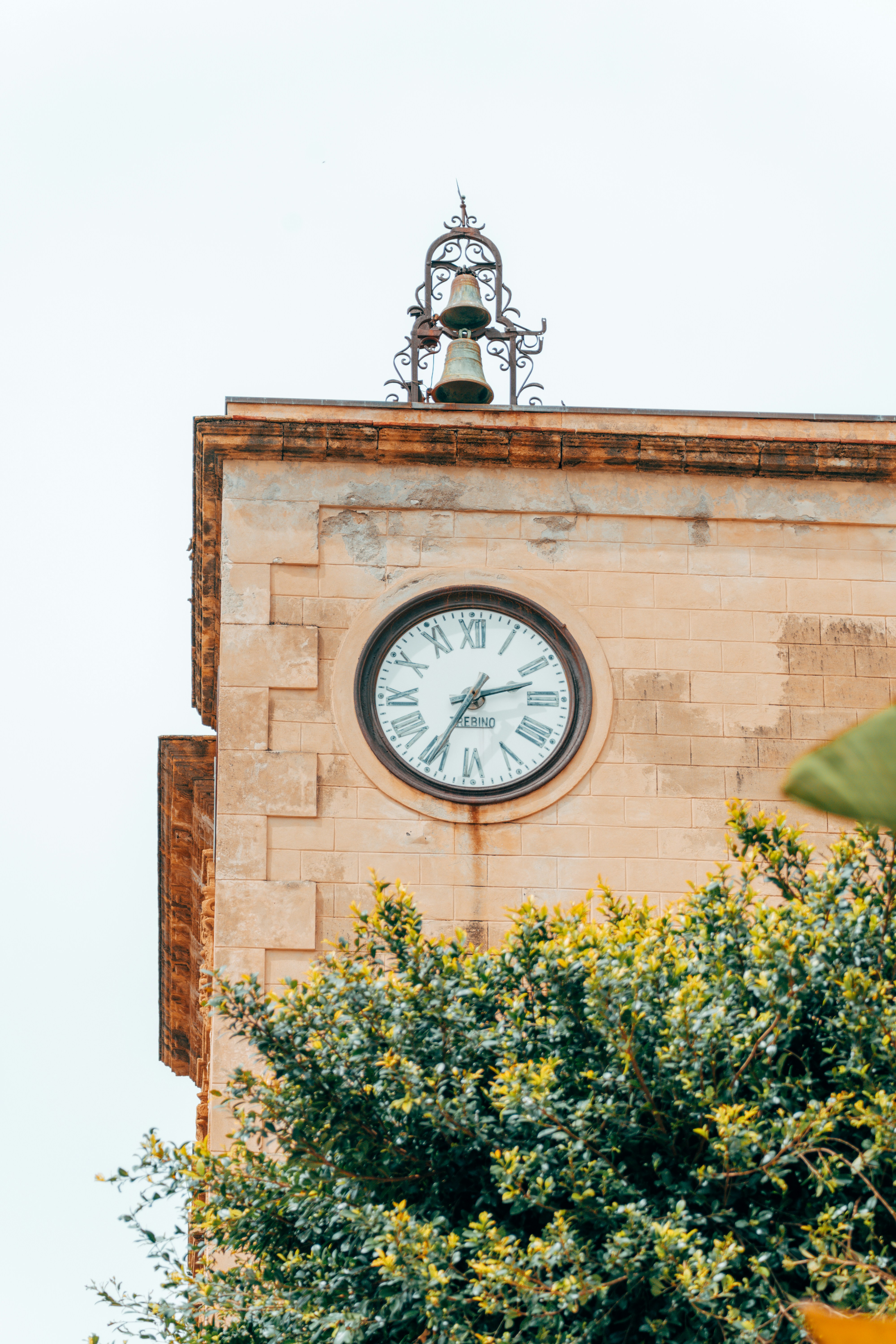 Clockwork on Stone: a sunlit tower with an ornate bell
