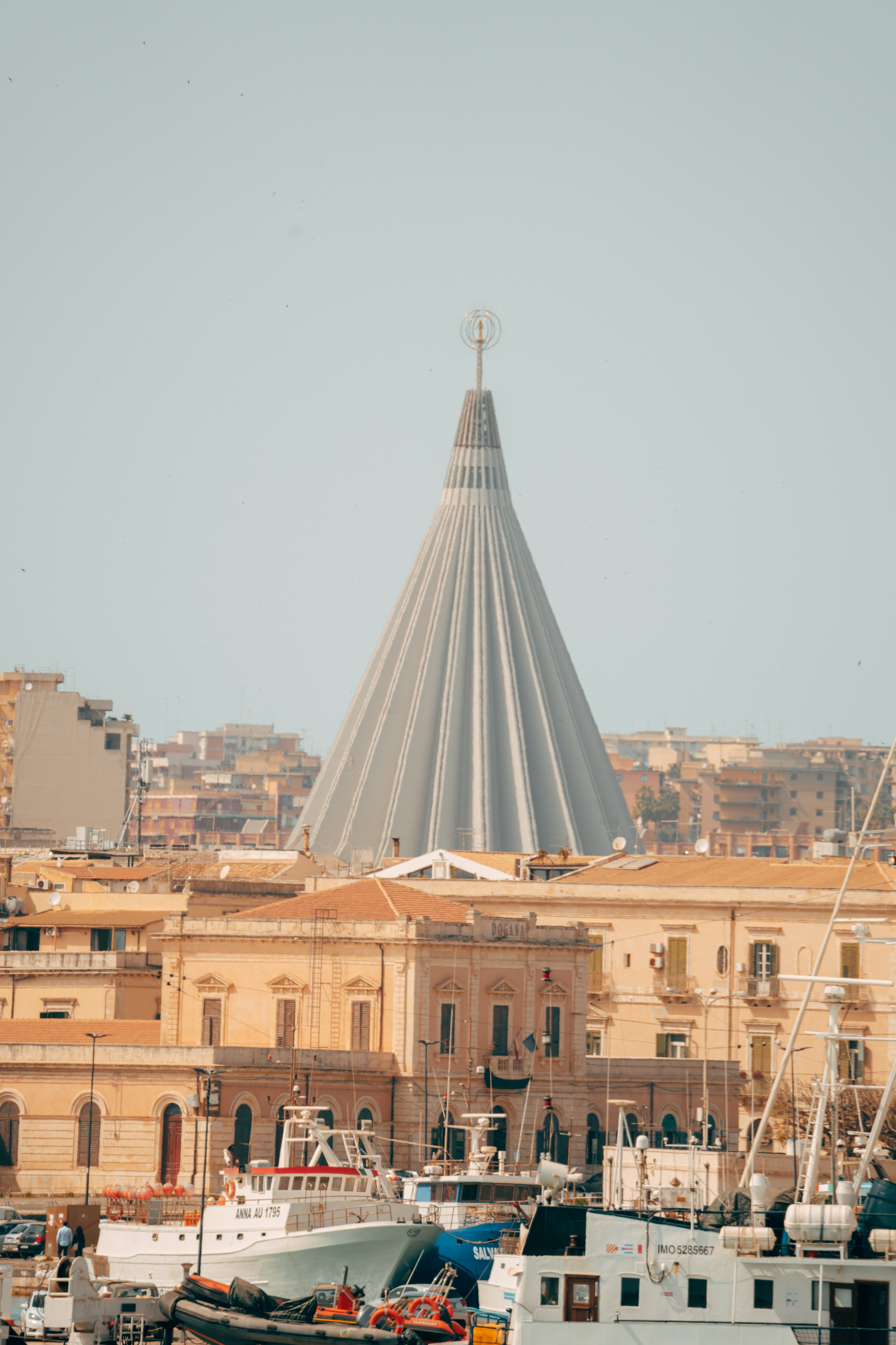 Harbor Monolith: The Conical Spire Rising Above the Golden Waterfront