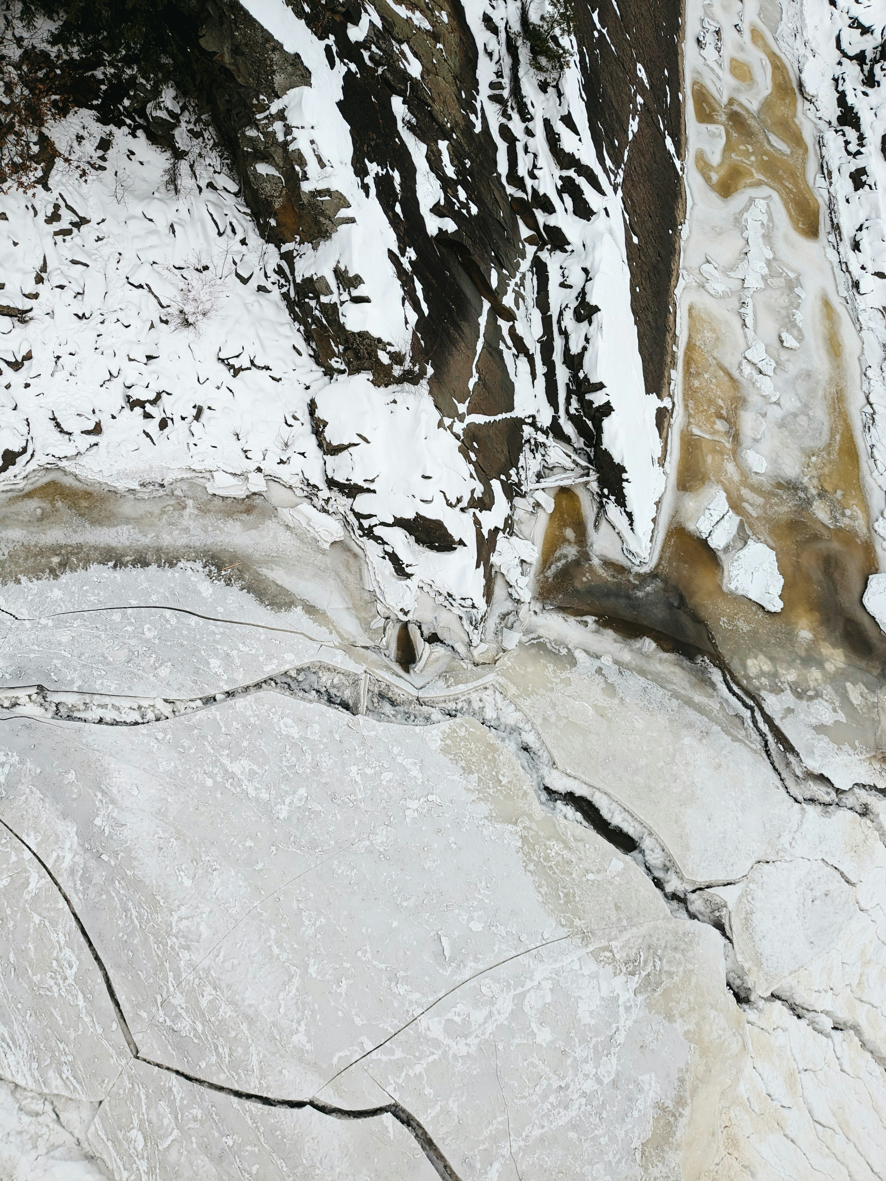 Snow-veined Rock: Close-Up on Cracked Granite Surface