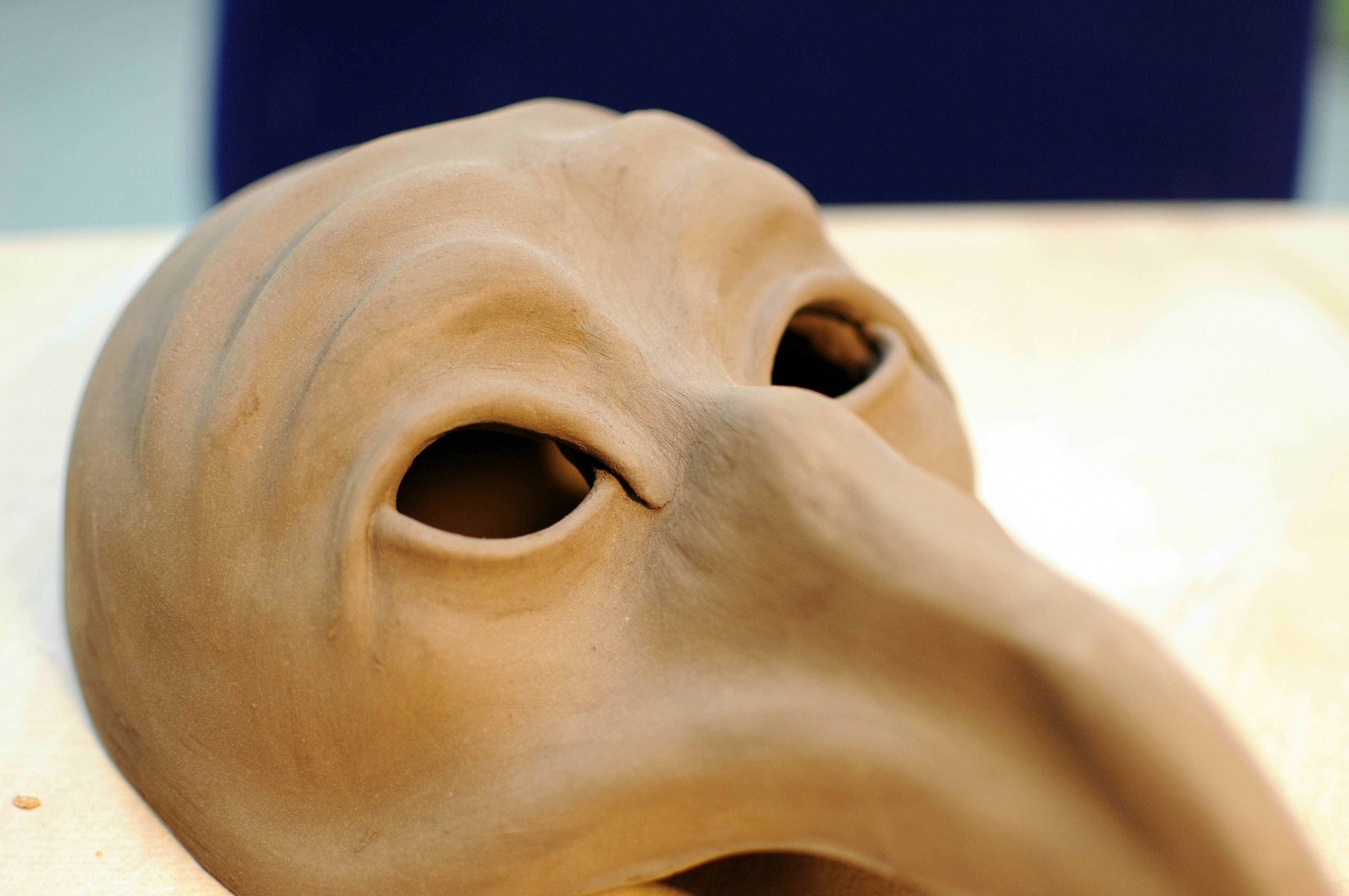 Clay Mask in Soft Workshop Light: A Close-Up Study of Form and Shadow