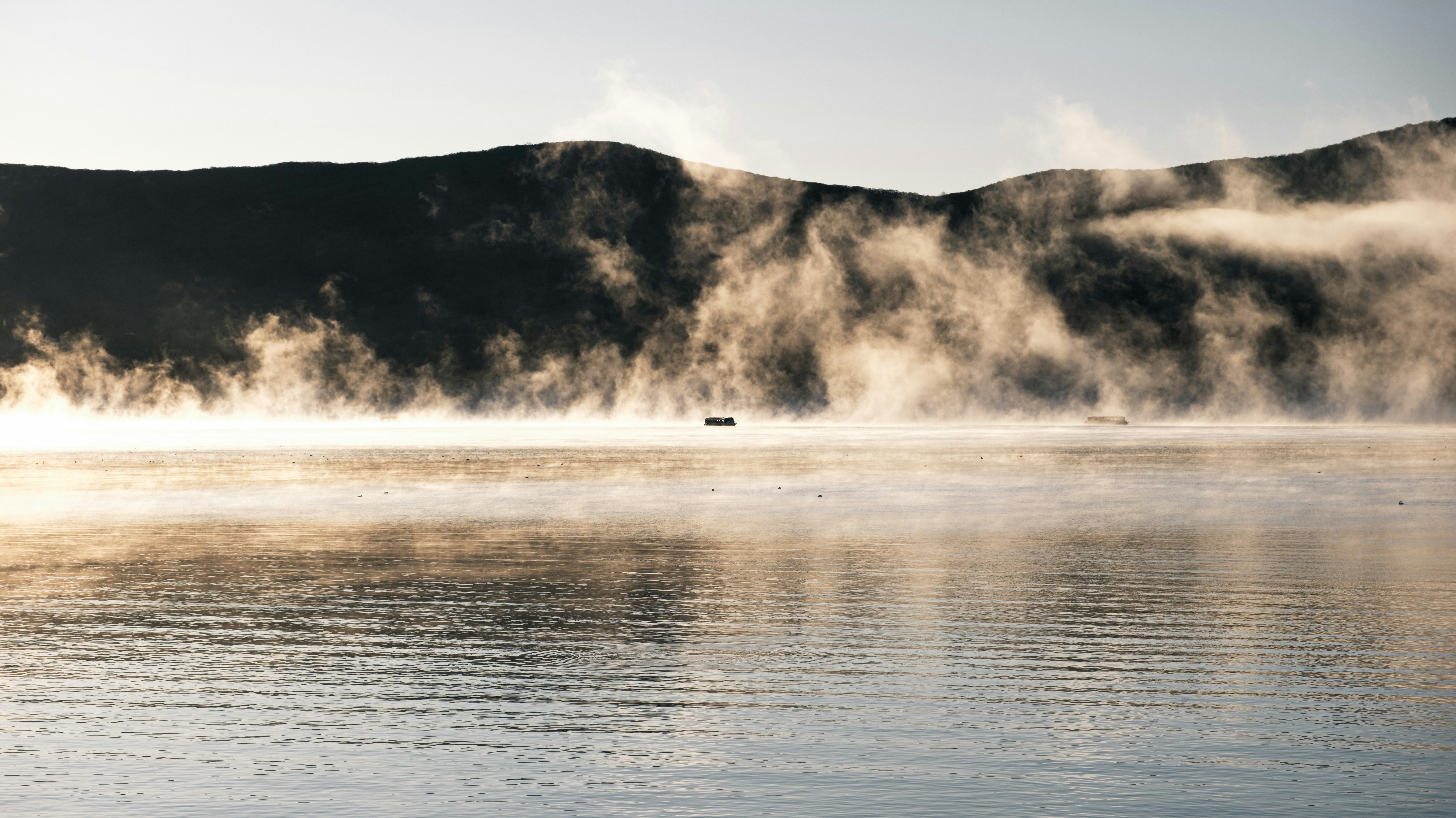 A body of water with steam rising from it photo – Free Nature Image on ...