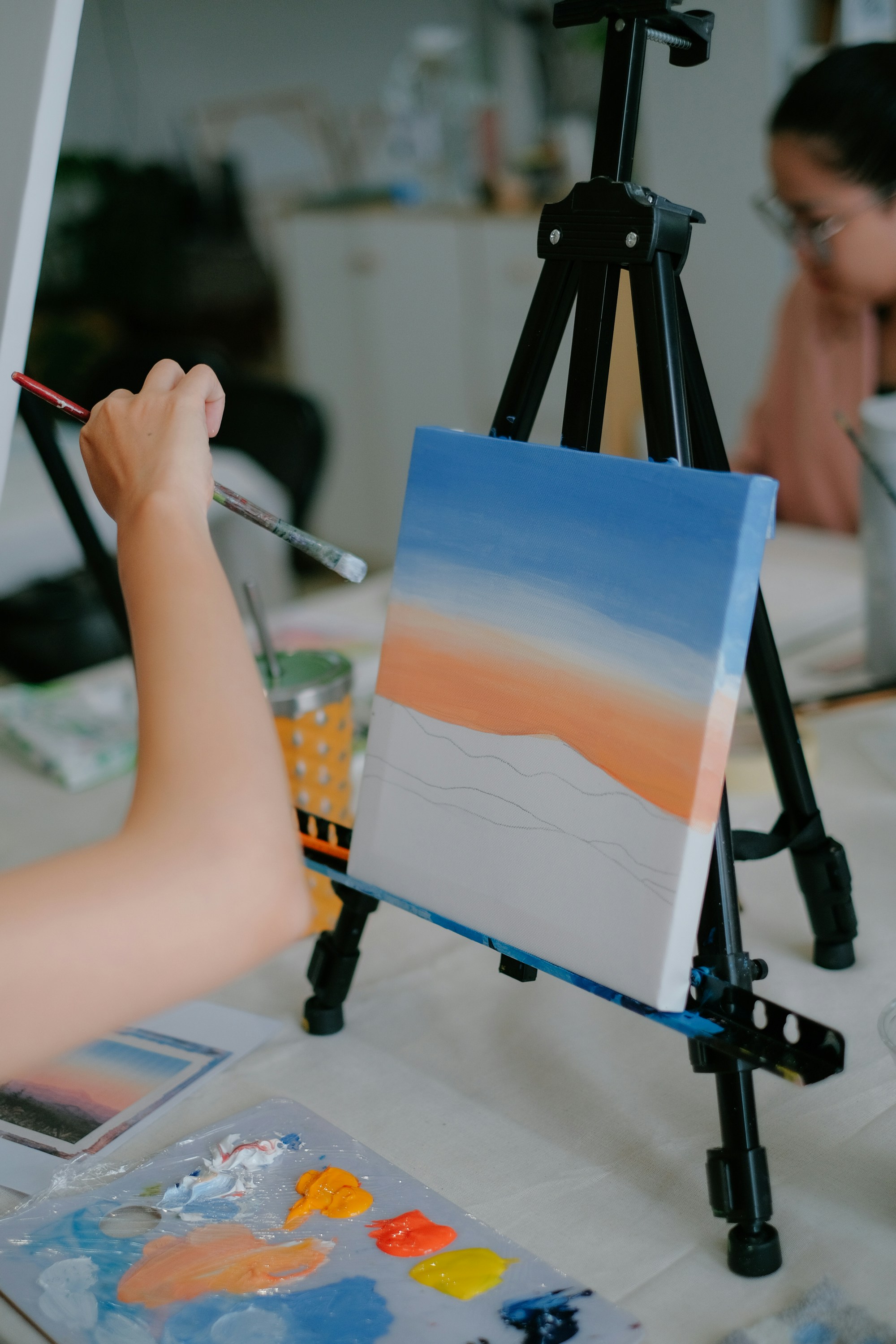 A person is painting a picture on a canvas photo – Free Canvas Image on ...
