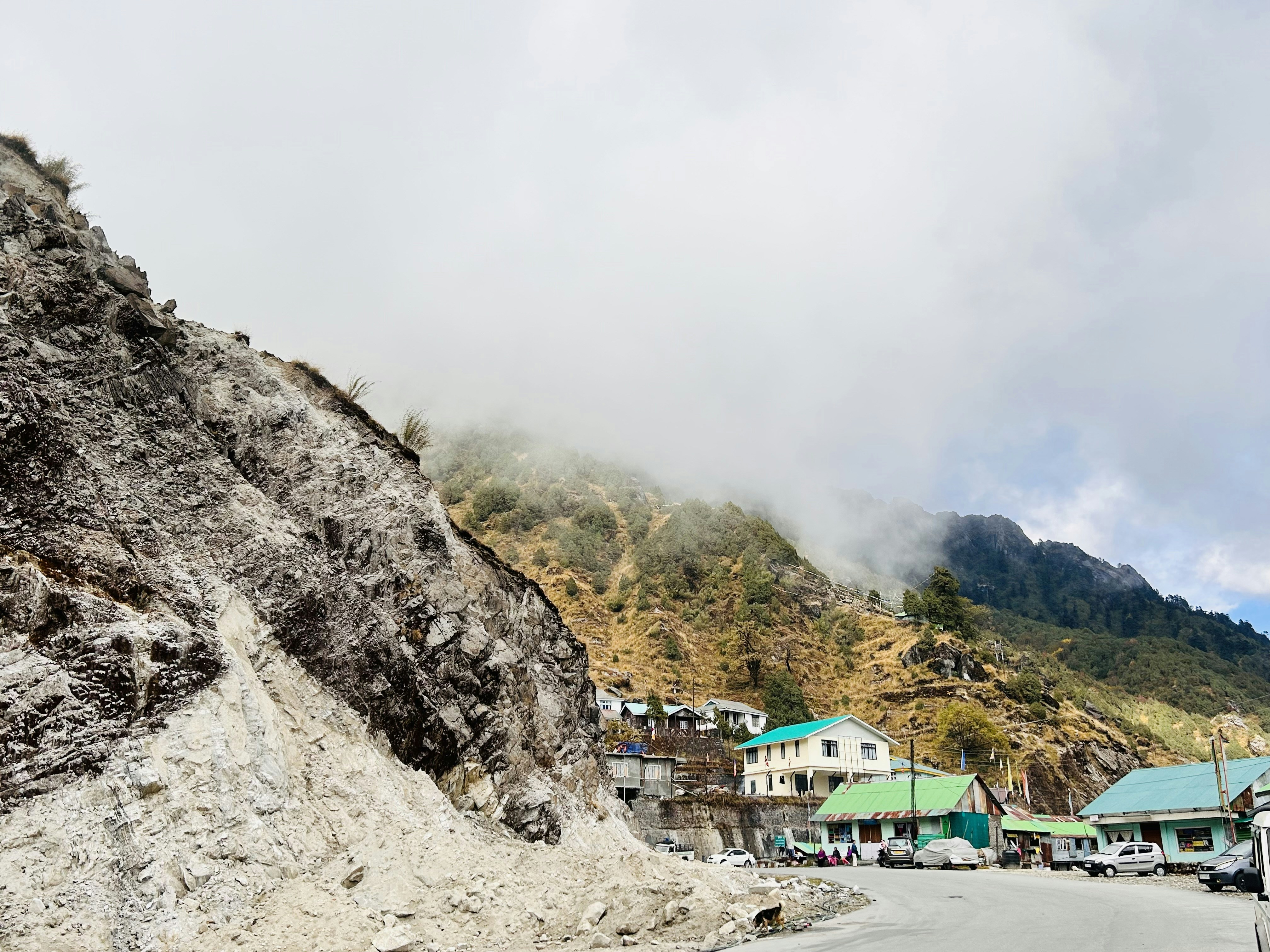 Mist-Clad Ridge, Green-Roofed Village at the Foot of Granite