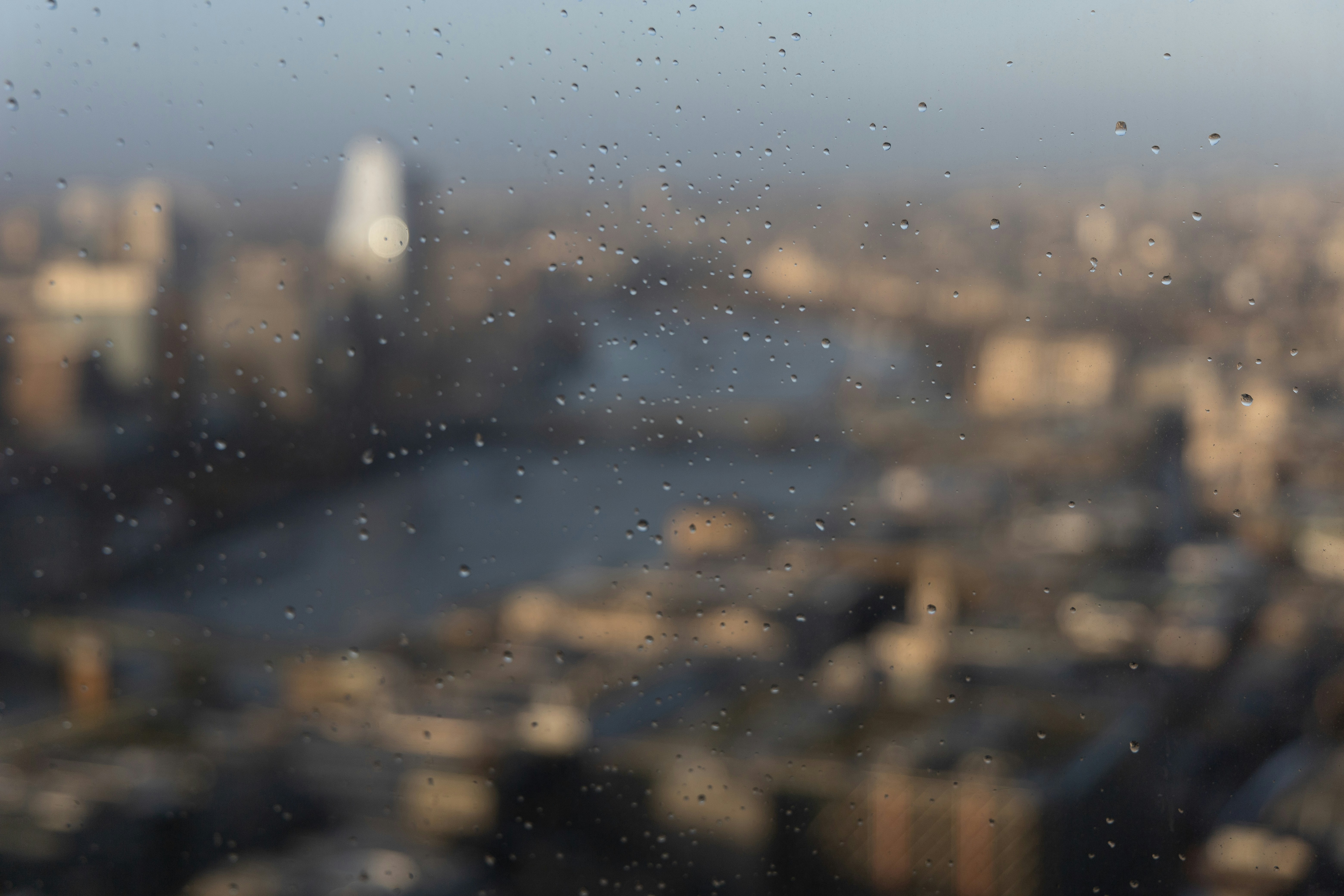 Rain on Glass: A Soft-Focus Vista of a City at Dawn