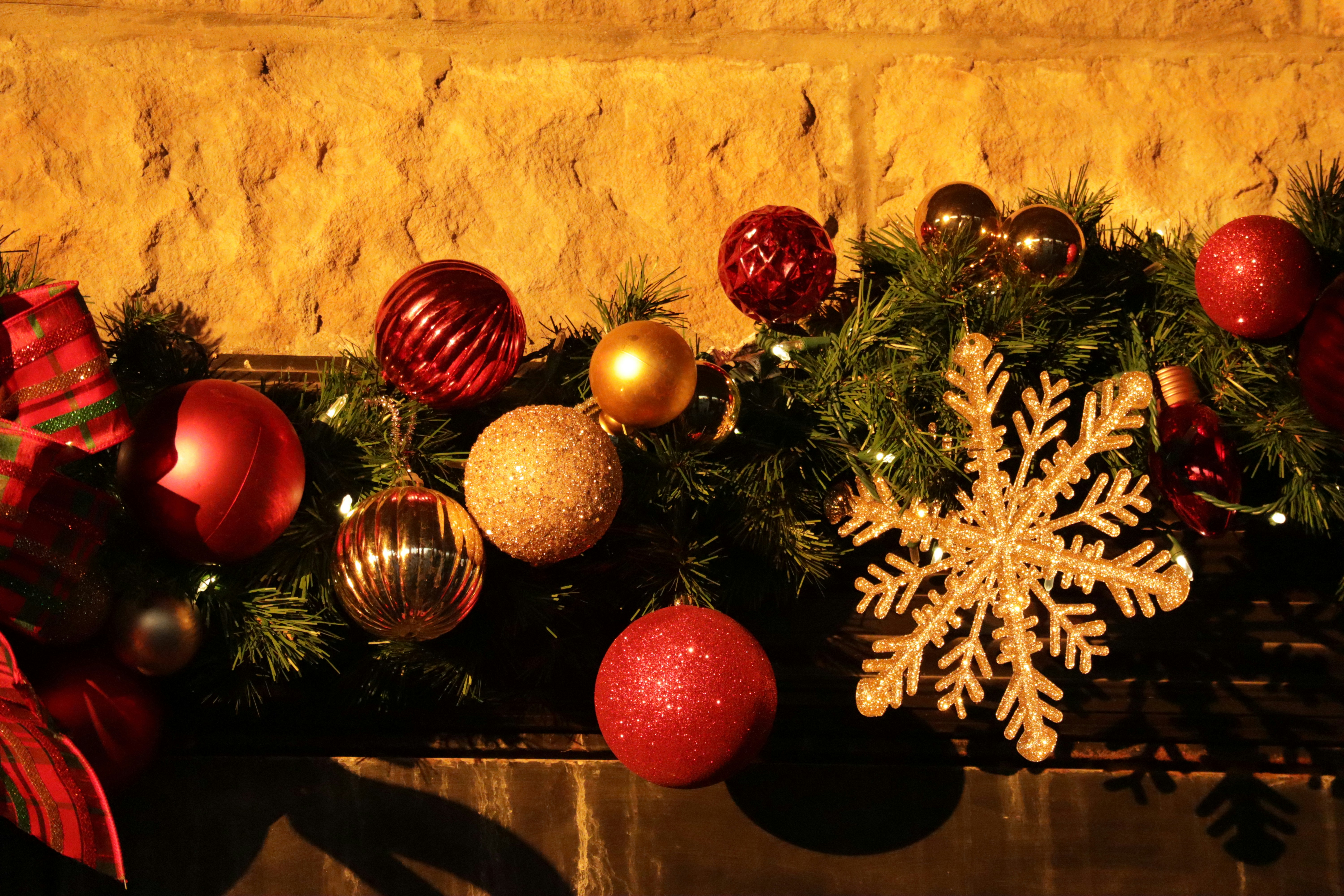 Snowflake Spotlight on a Warm Mantel of Christmas Ornaments