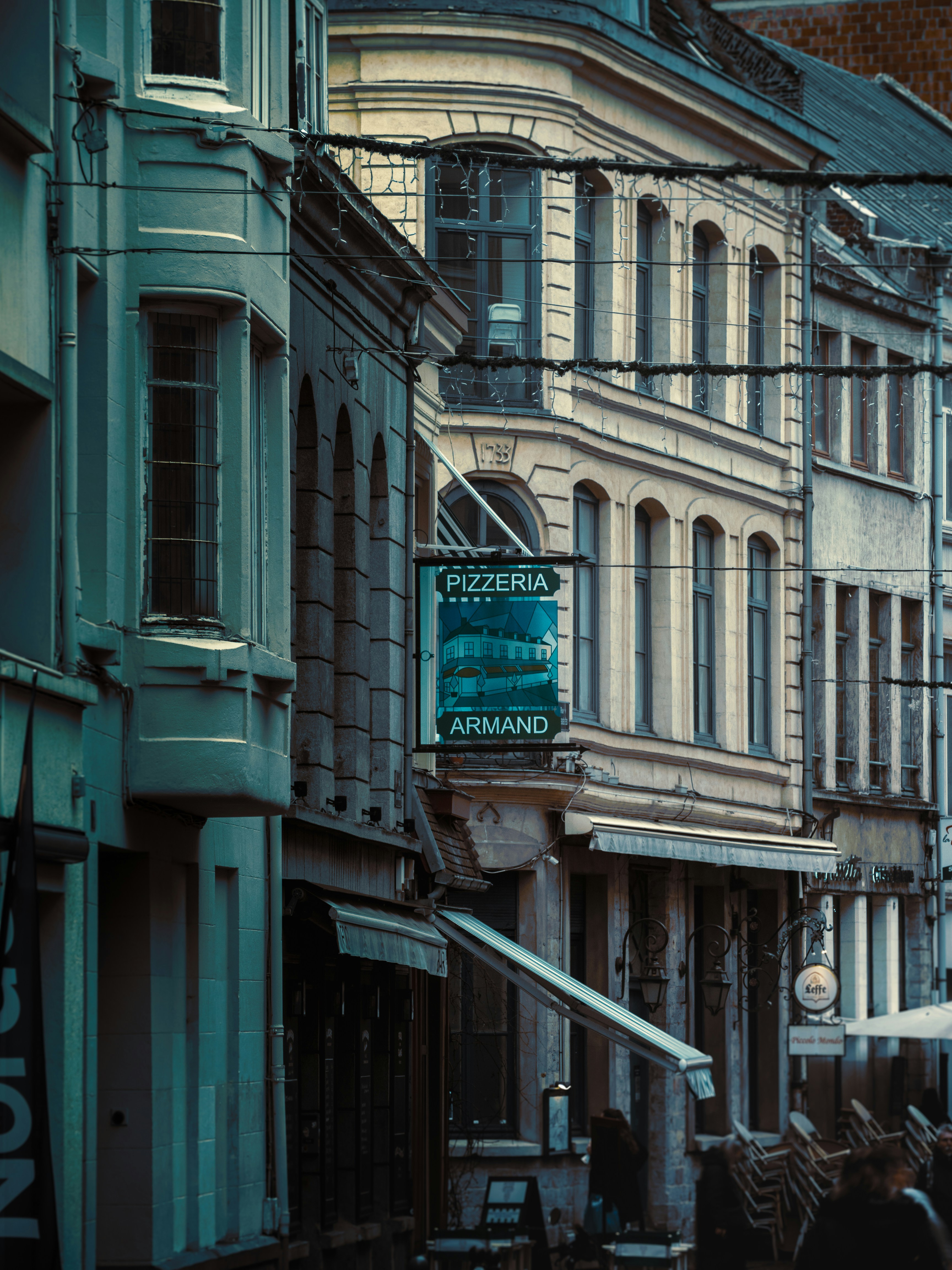 Teal Twilight Signage: Pizzeria Armand Among Narrow European Facades