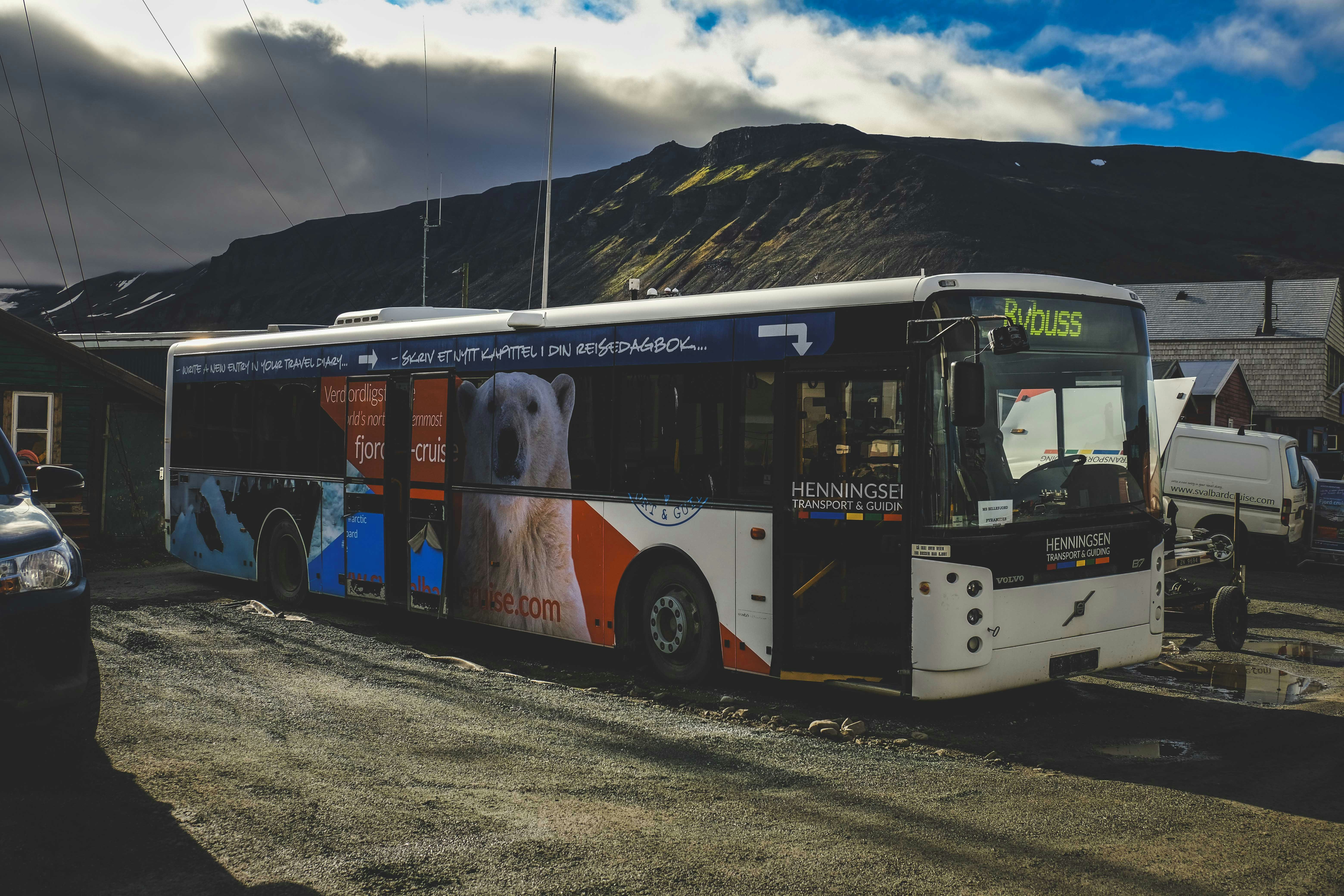 Bus at the Edge of a Nordic Town Under Rugged Skies