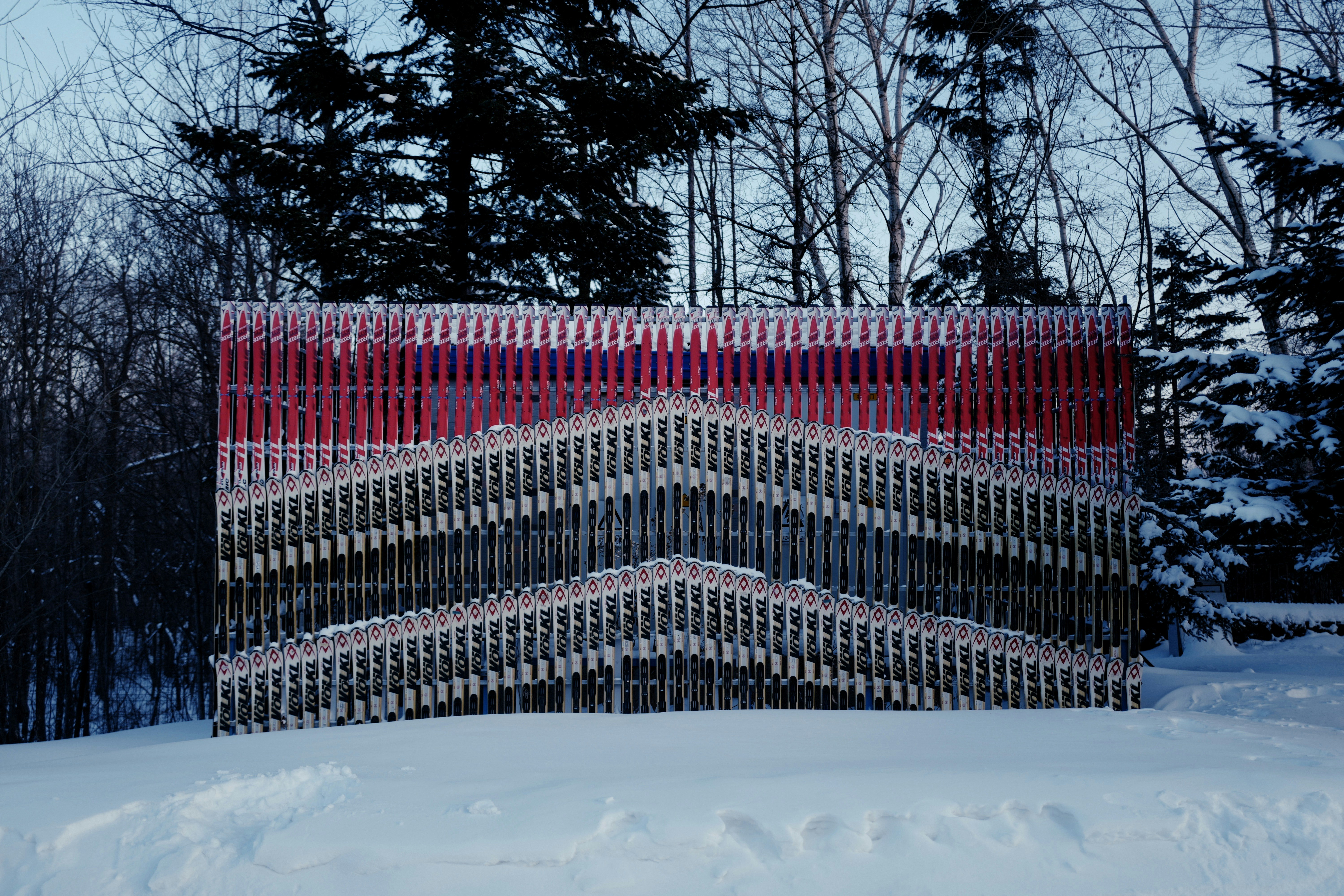 A building made out of wooden slats in the snow photo – Free ...