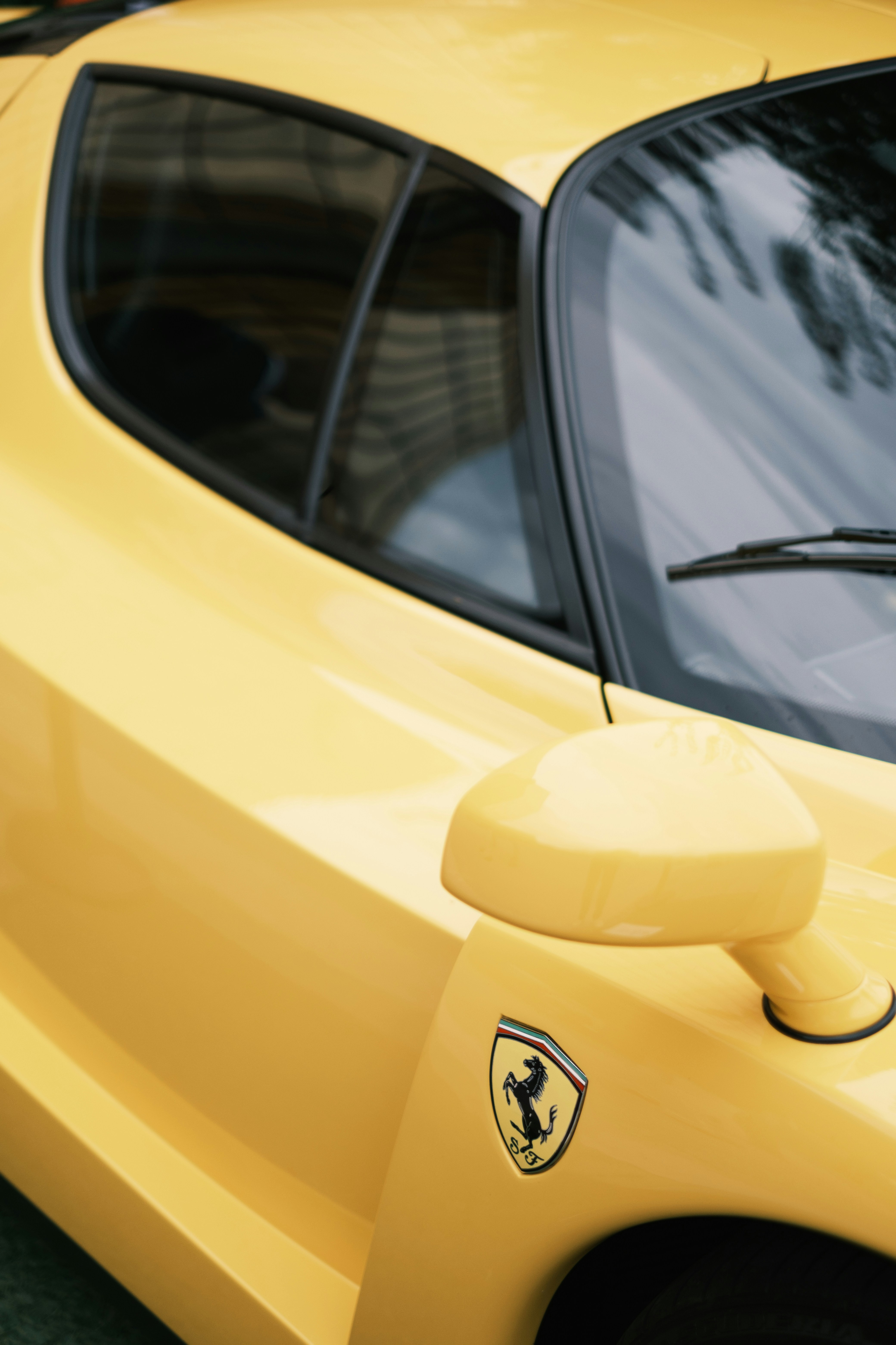 Sunlit Curves and the Prancing Horse: Close-Up on Ferrari's Yellow Fender Emblem