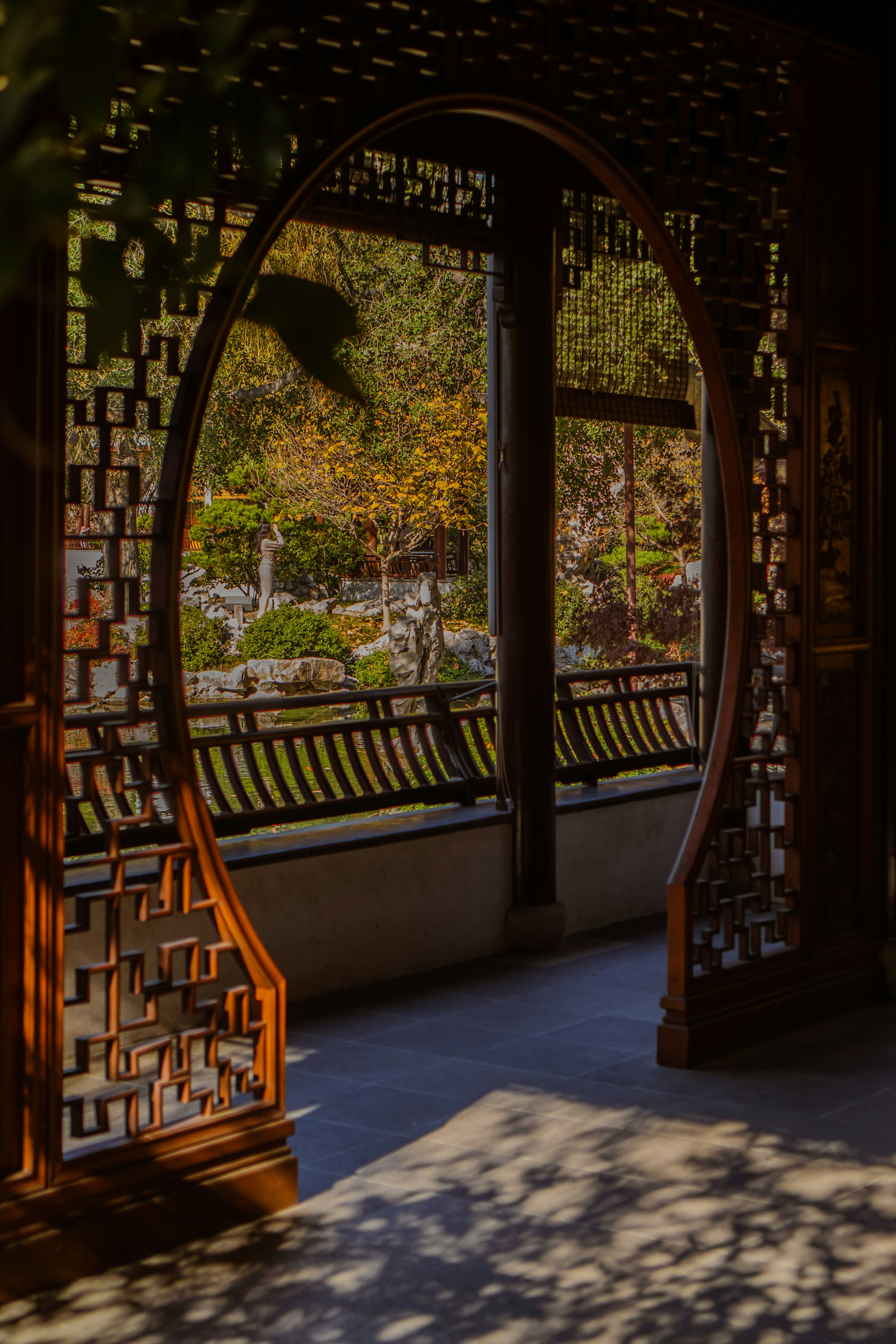 A view of a park through a circular window photo – Free Art gallery and ...