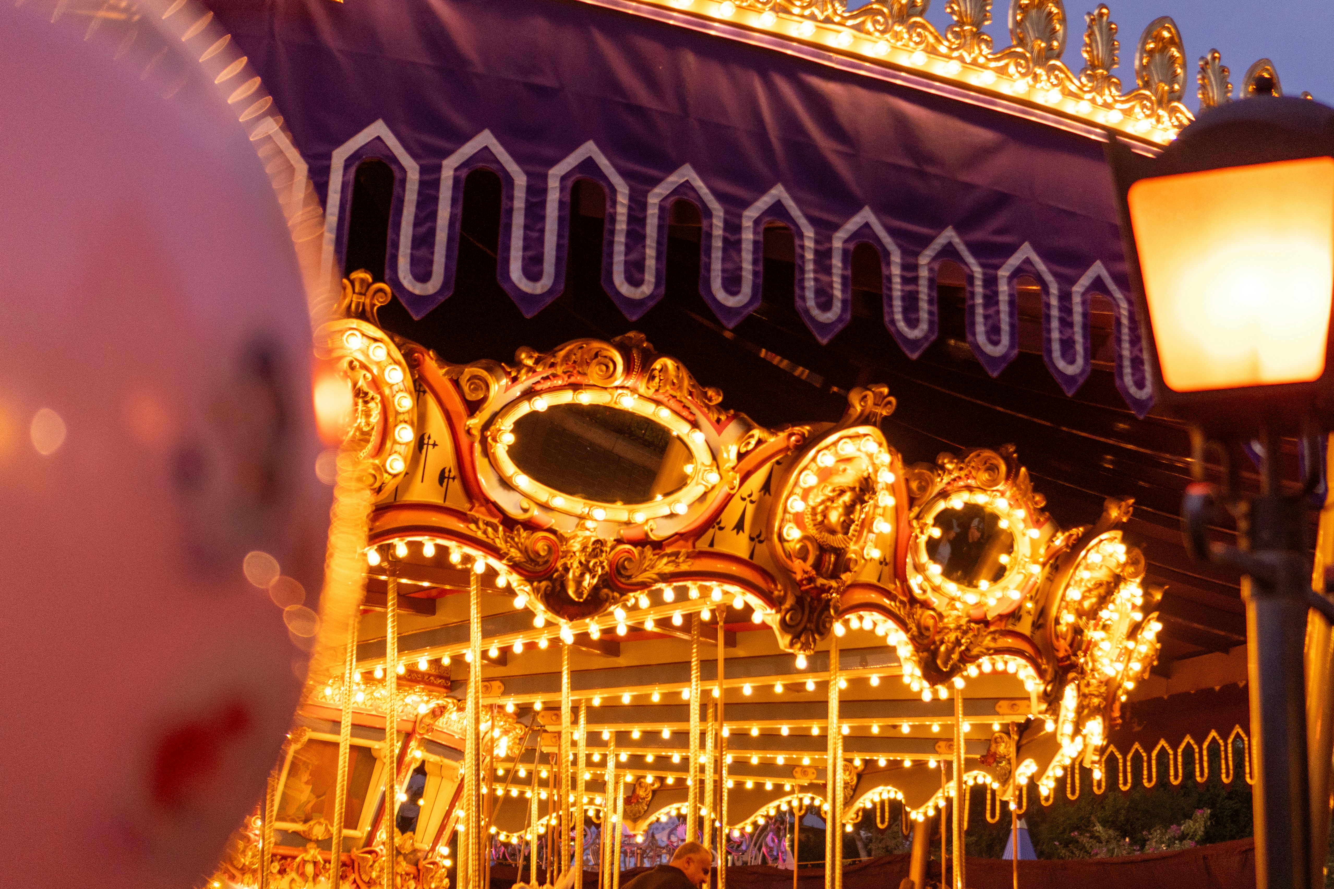 A merry go round at night with lights and decorations photo – Free ...
