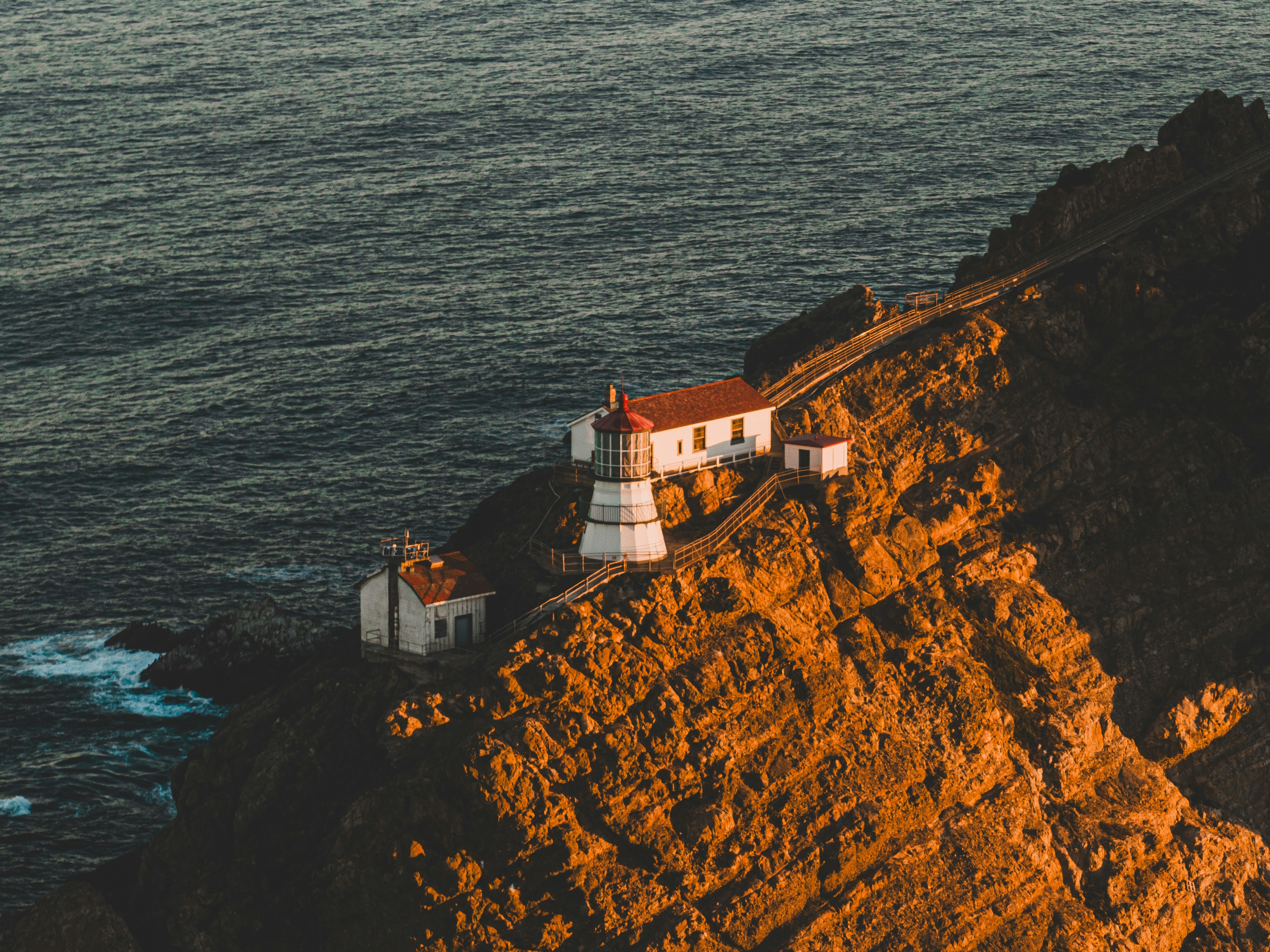 A lighthouse on a rocky cliff by the ocean photo – Free Point reyes ...