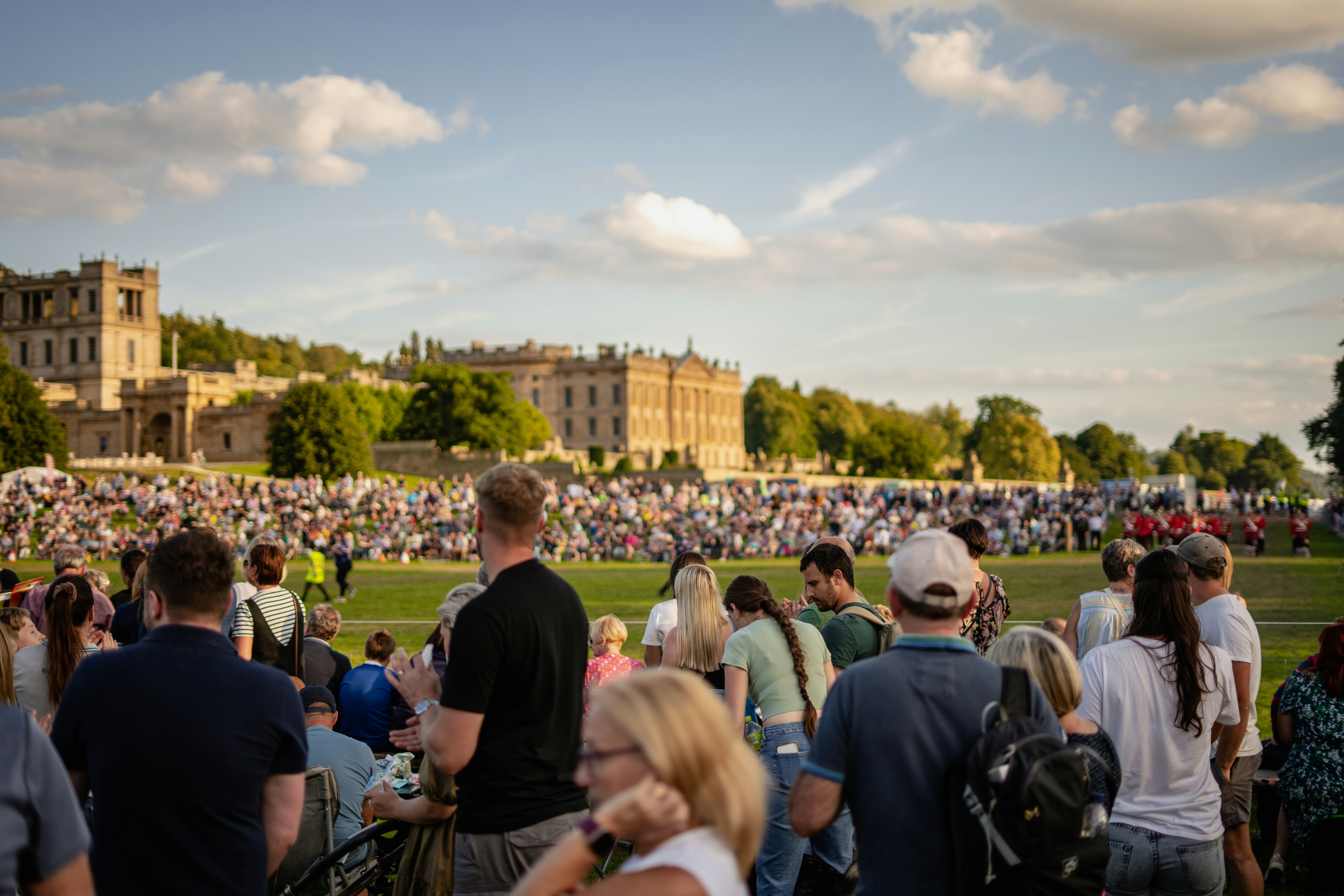 A crowd of people standing in front of a castle photo – Free Woman ...