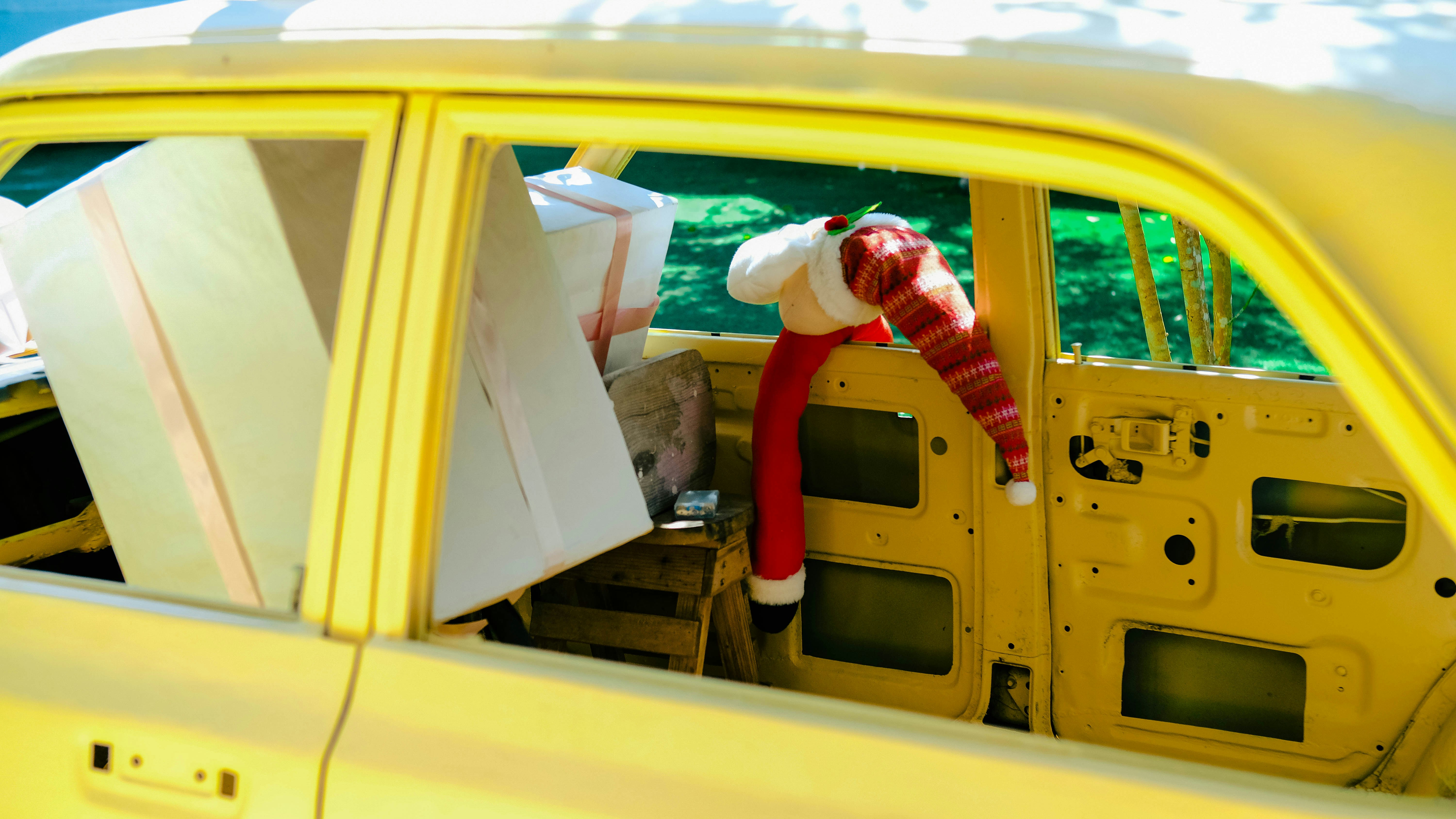 A yellow car with a stuffed animal in the passenger seat photo – Free ...