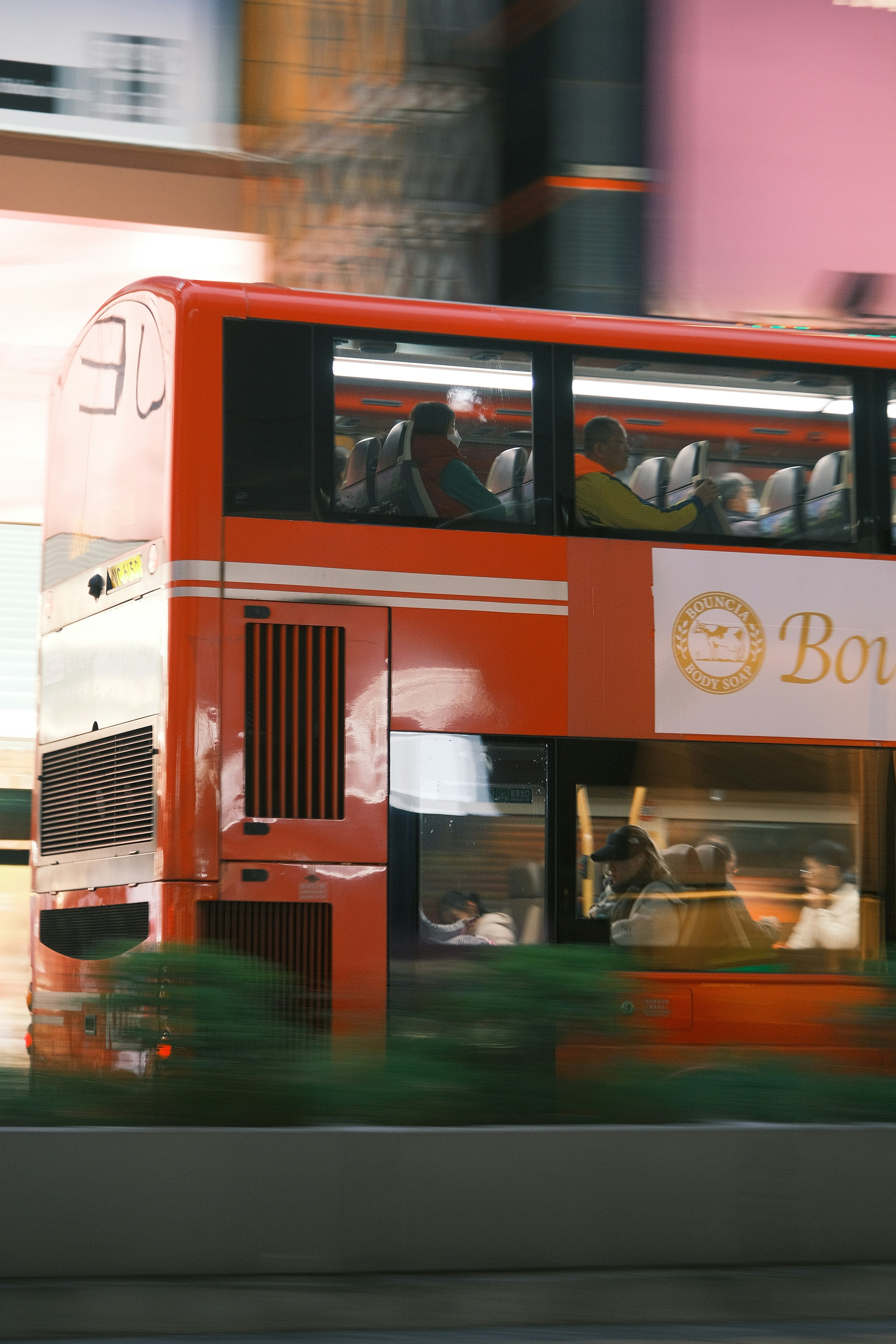 Rushing Red: Passengers in a Blurred Urban Vista