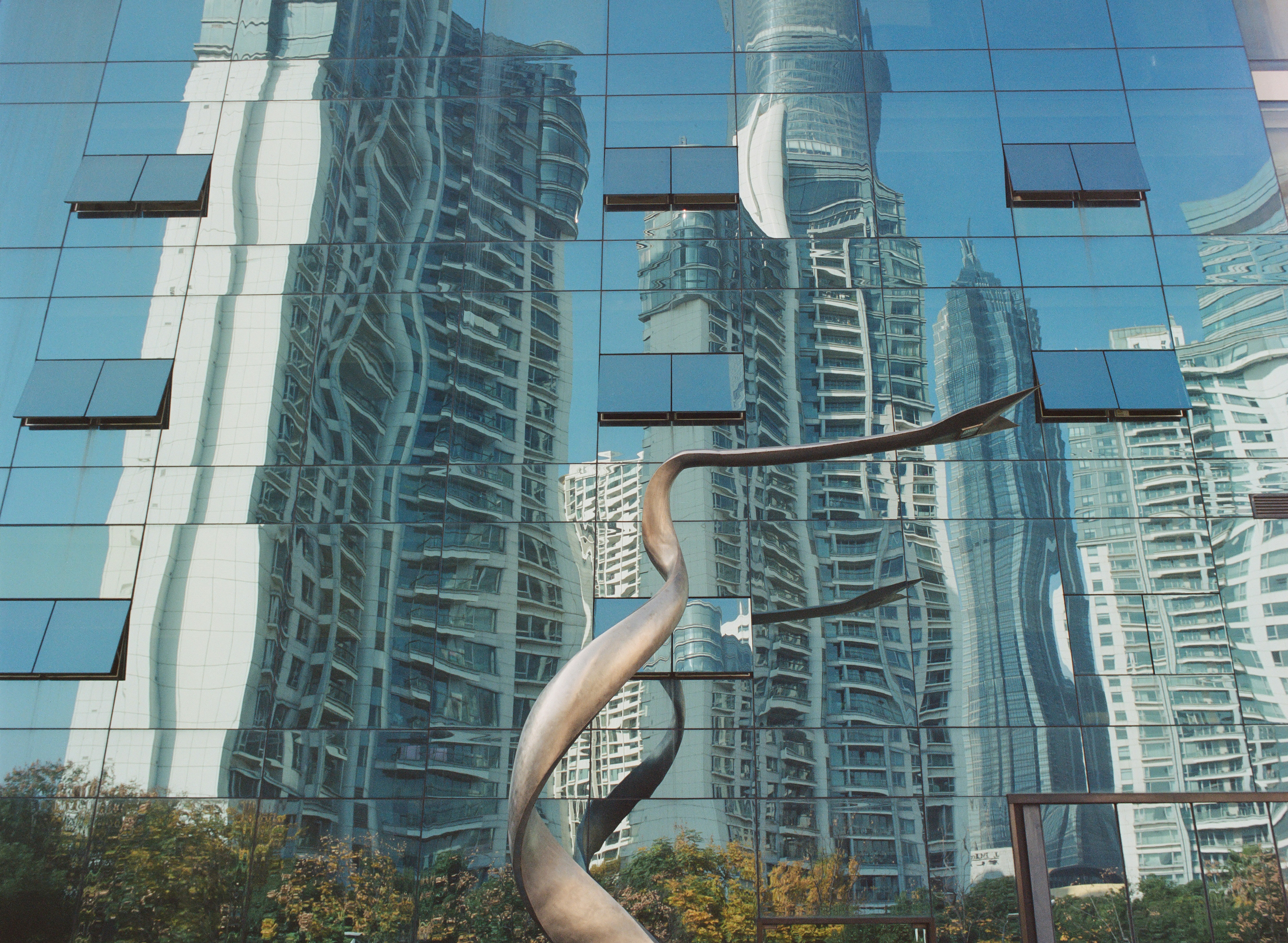 A statue of a snake in front of a building photo – Free Building Image ...